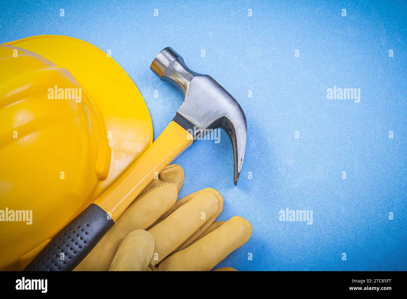 Claw hammer safety gloves building helmet on blue background ...