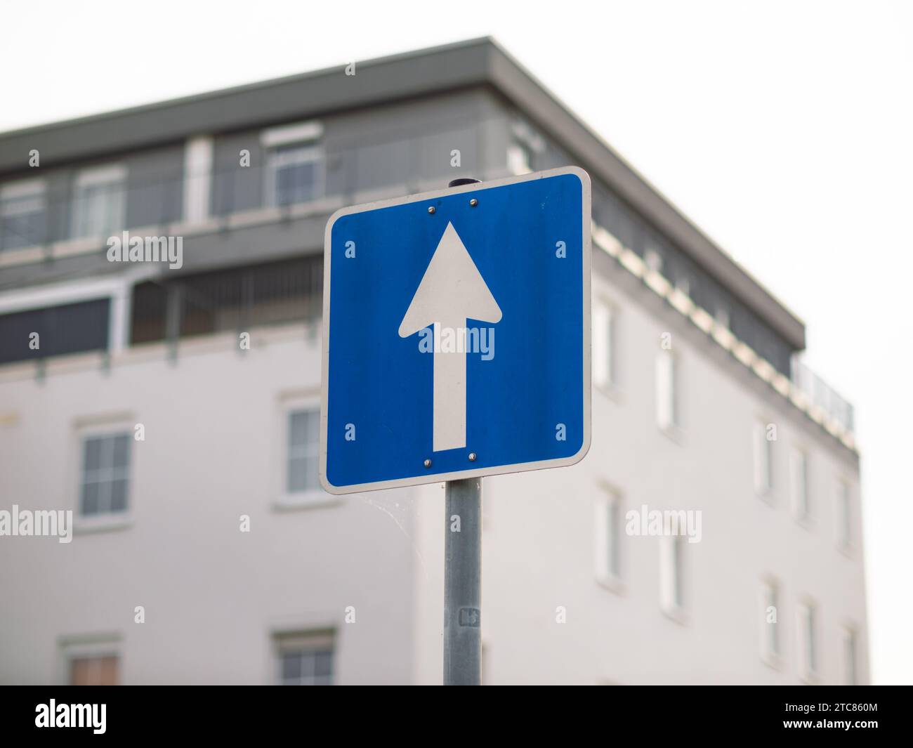 One-way street sign in Germany. The white arrow on the blue square is ...