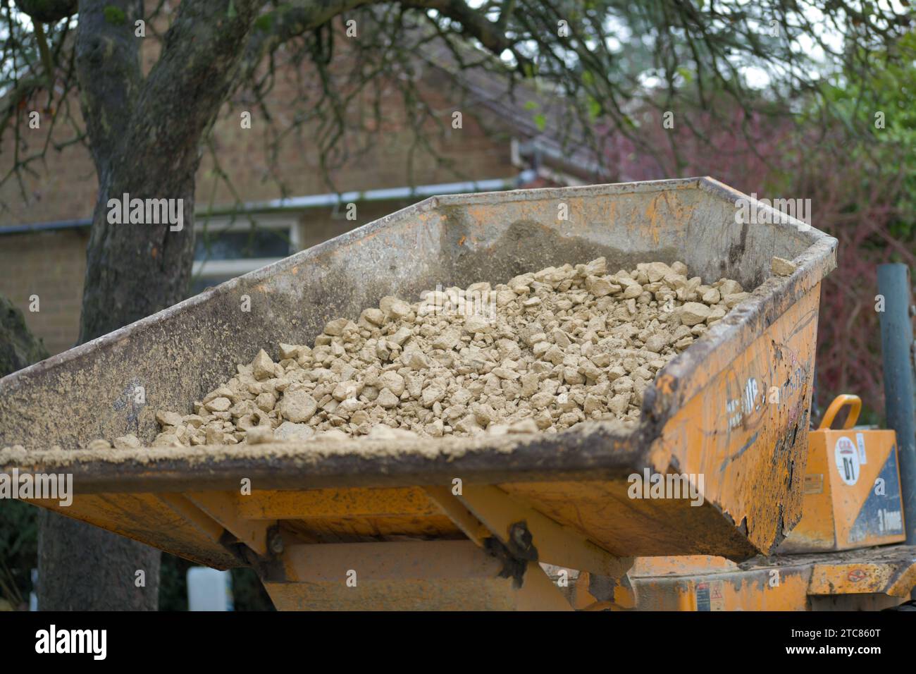 A yellow loader bucket filled with limestone Stock Photo - Alamy