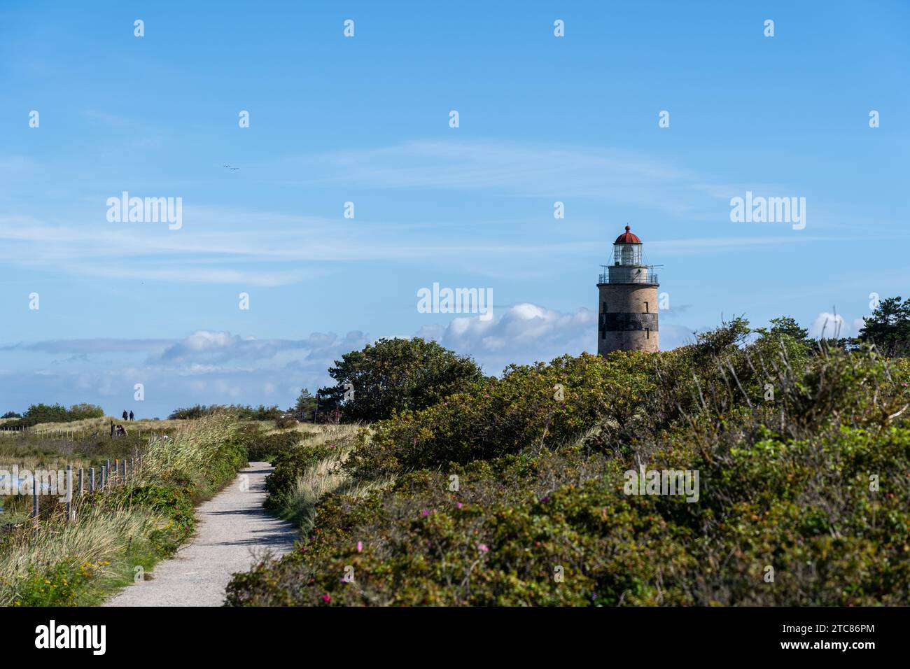 A picturesque view of a lighthouse and tranquil body of water with a ...