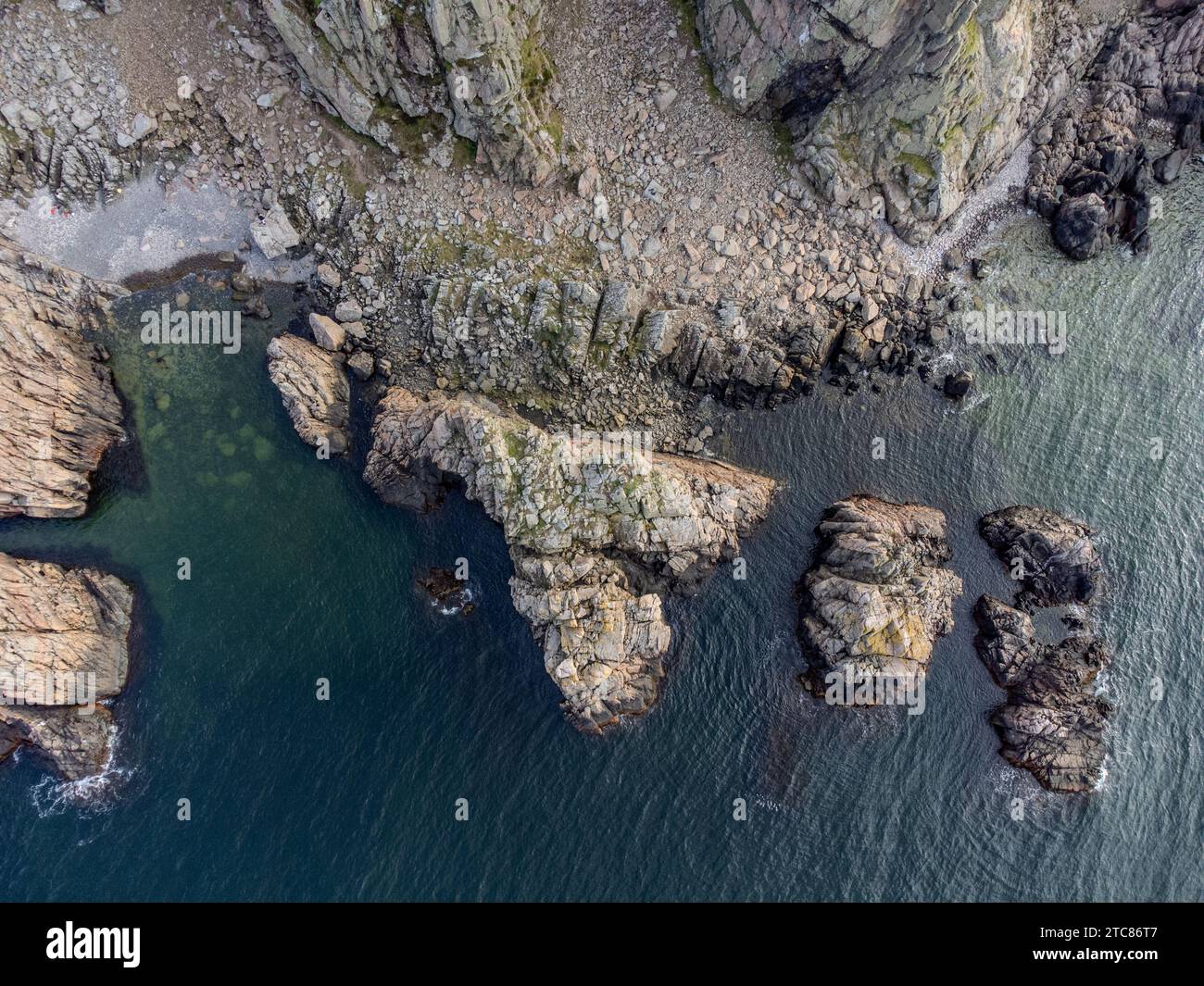 A picturesque landscape featuring a serene beach bordering dramatic ...