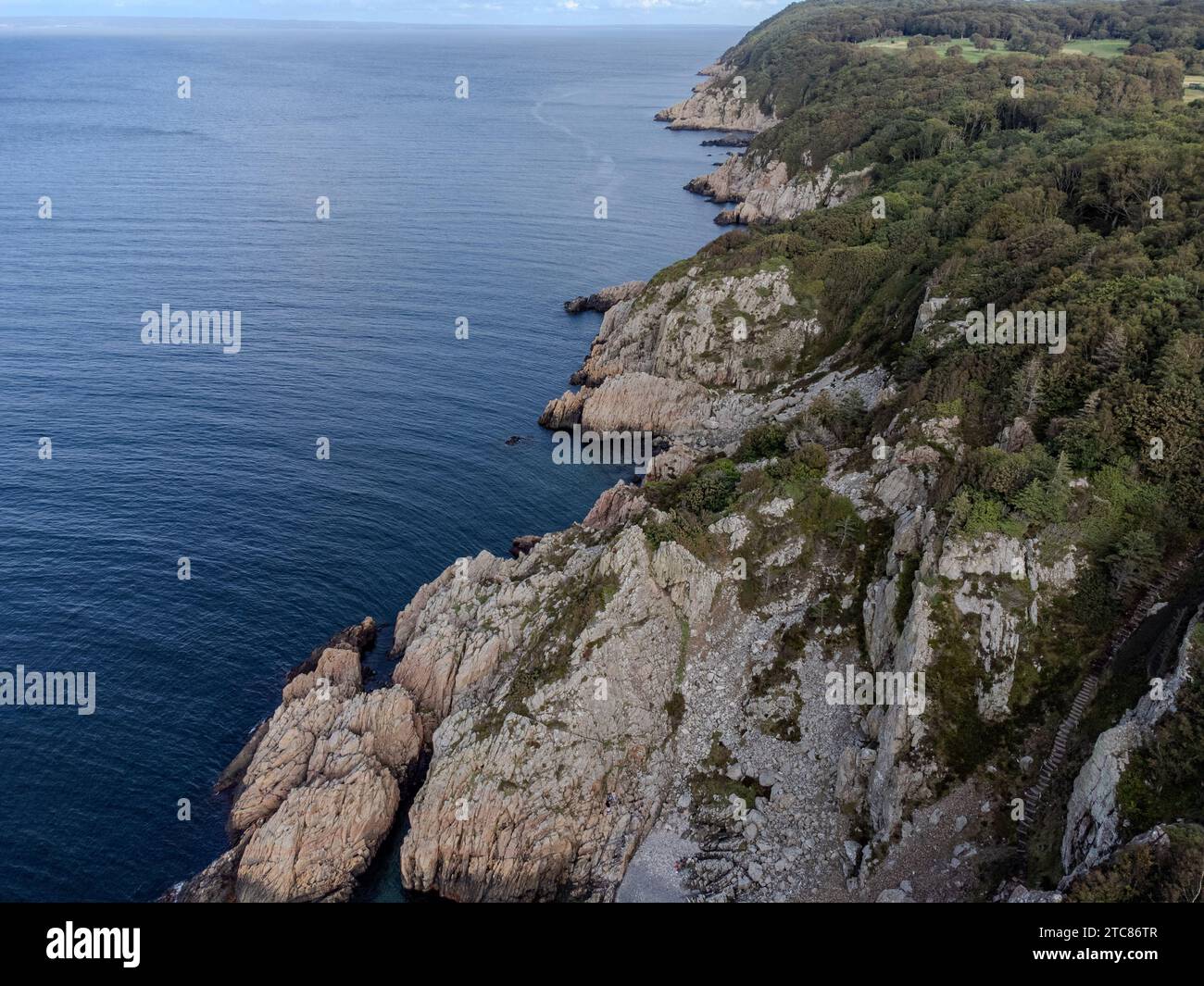 A scenic view of a coastal landscape featuring a shoreline overlooking ...