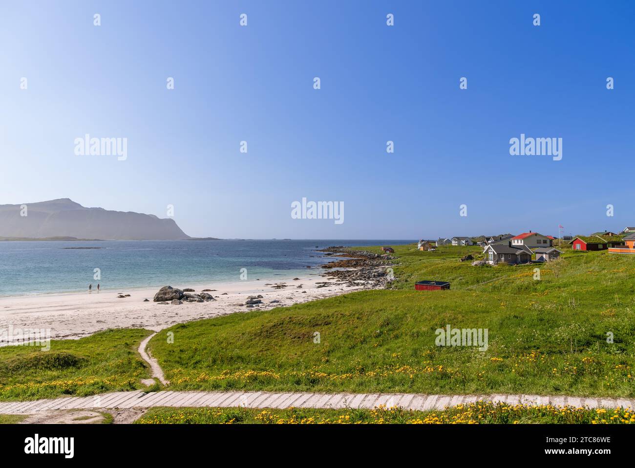 Sunny weather illuminates the pristine Jusnesvika Bay at Rambergstranda ...