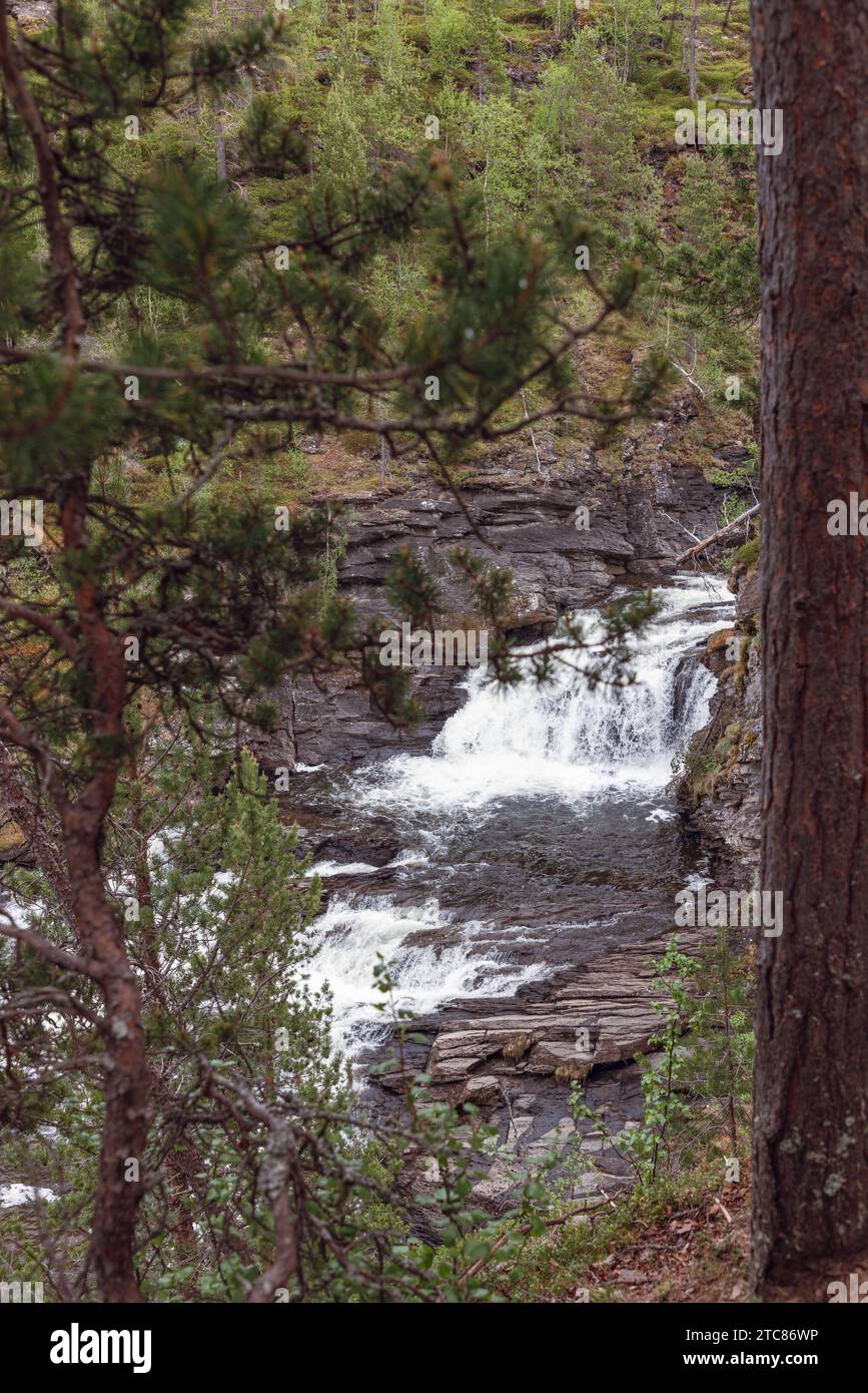 Vertical shot capturing the dynamic cascades between granite cliffs ...