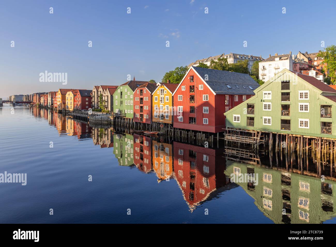 Sunset over the Nidelva River with iconic wooden houses along the banks ...