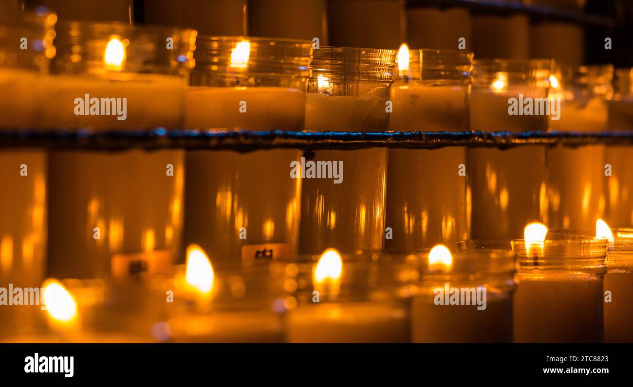 A picture of a row of lit candles on display in the Santa Maria de ...