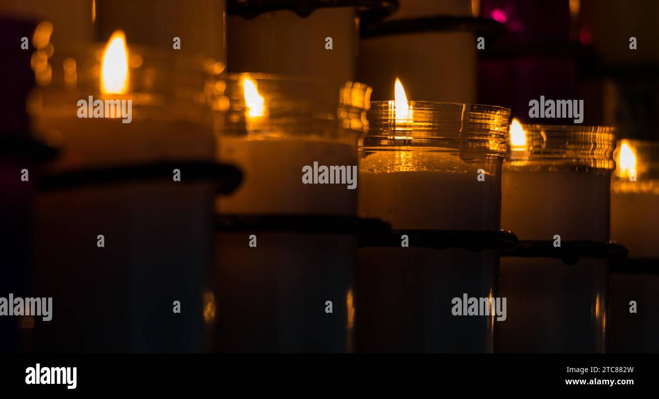 A picture of a row of lit candles on display in the Santa Maria de ...