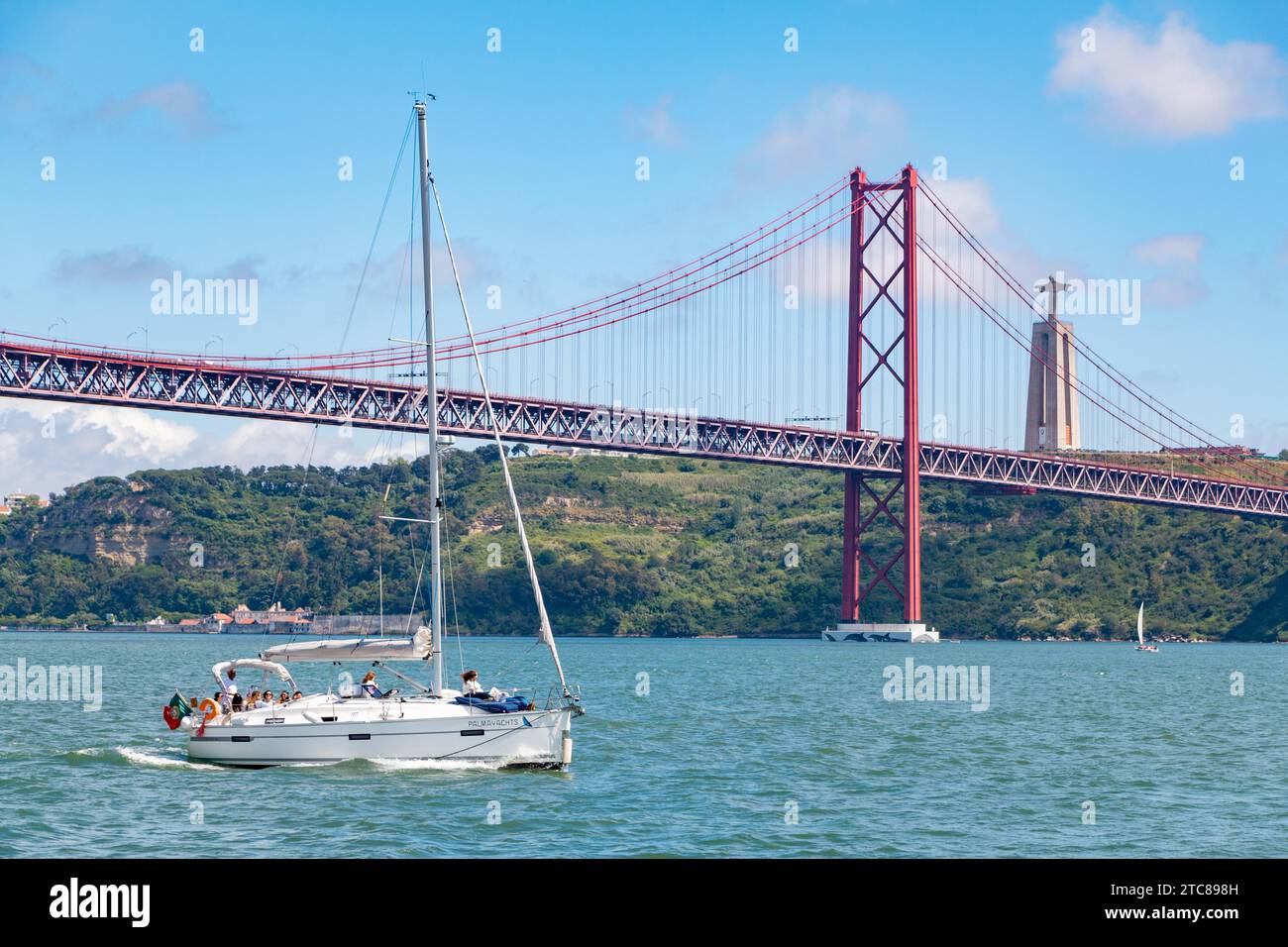 A picture of a sailboat sailing in the Tagus Tejo River, overlooked by ...