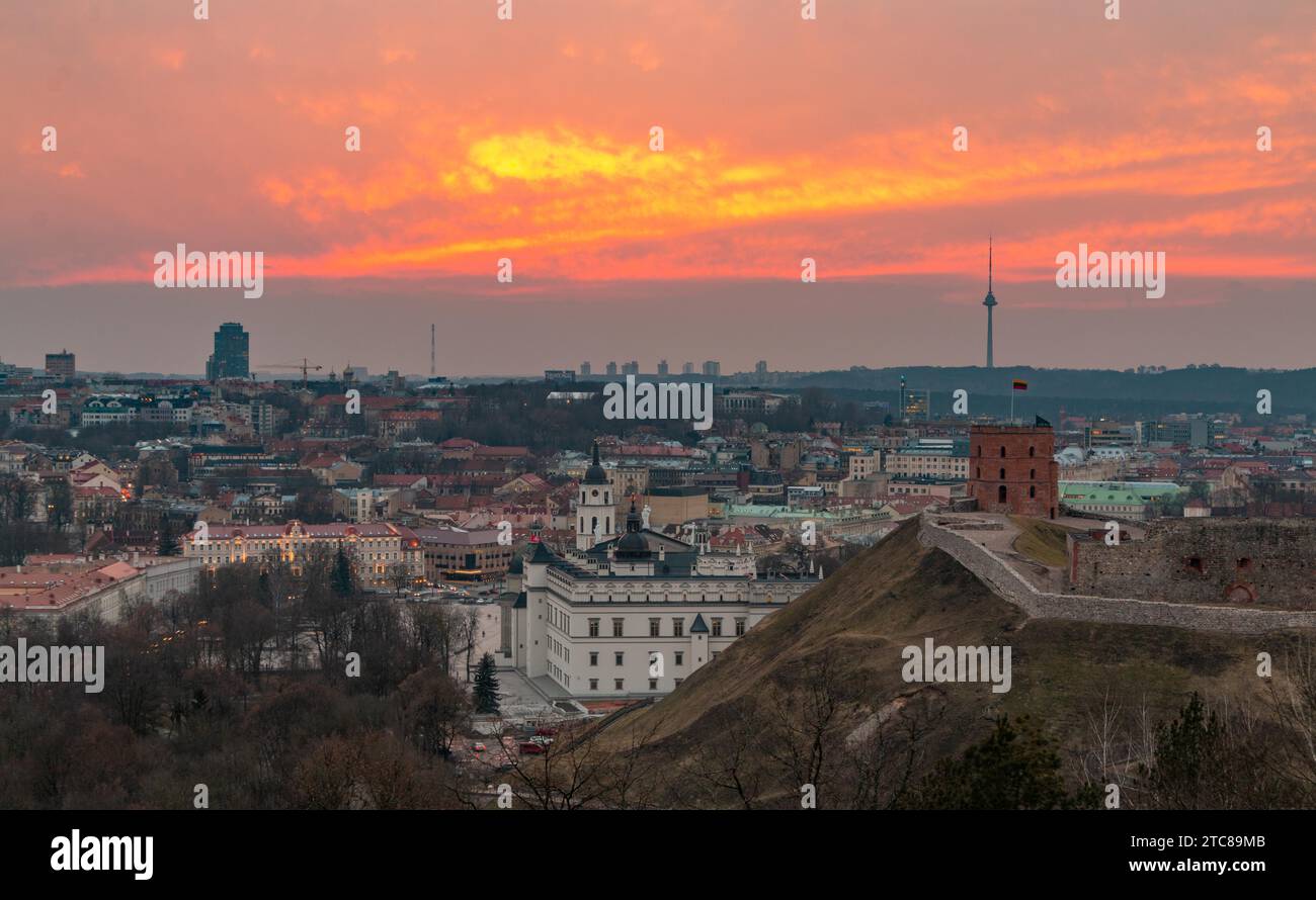 A picture of the sun setting over Vilnius, with the Gediminas Castle ...