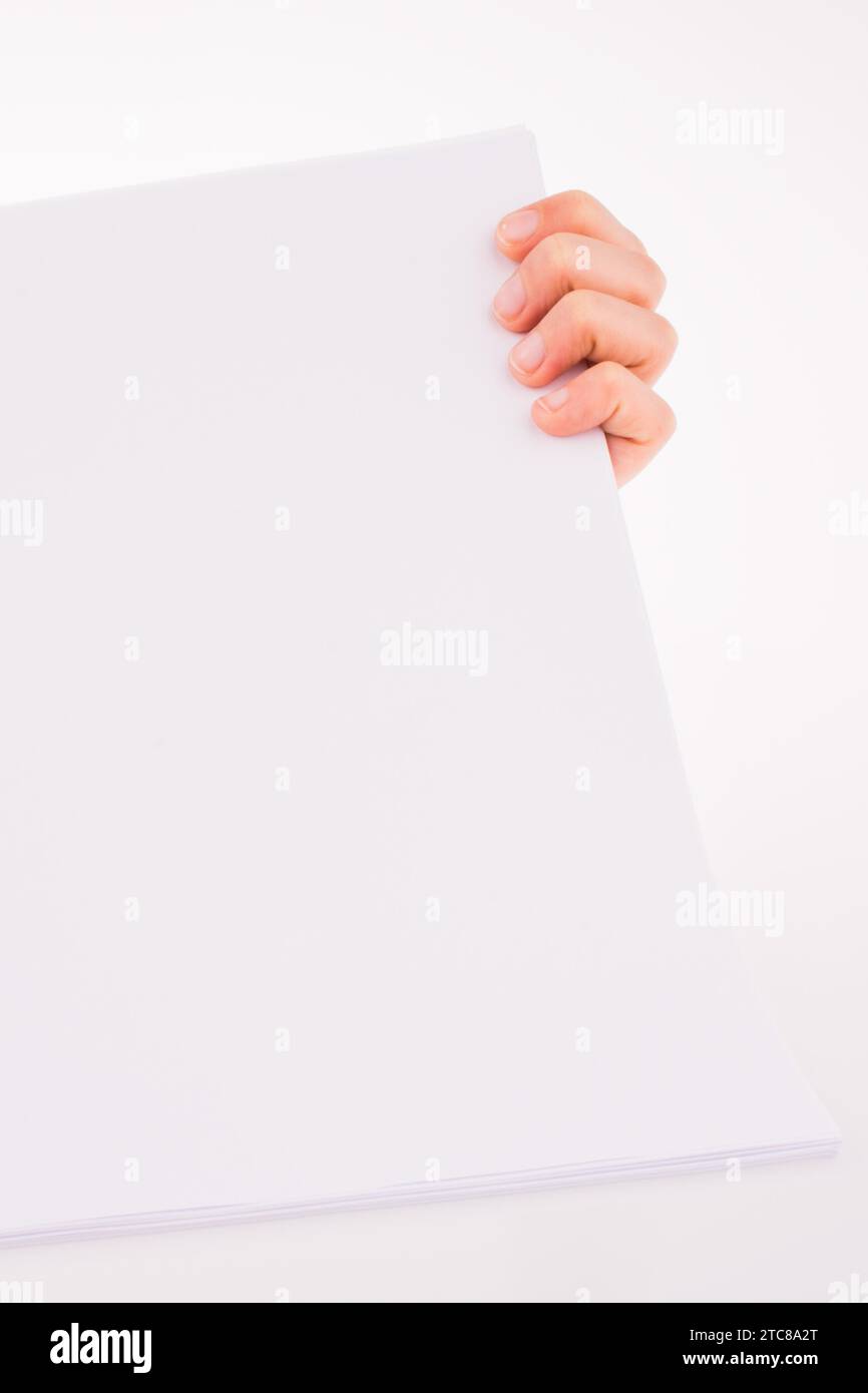 Hand holding a blank paper on a white background Stock Photo - Alamy