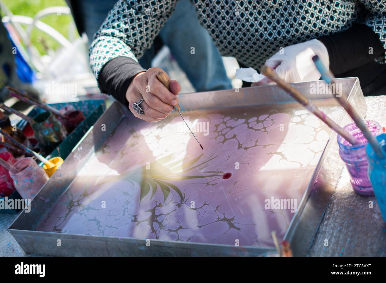 Hand drawing with stick stained inks on water surface Stock Photo - Alamy