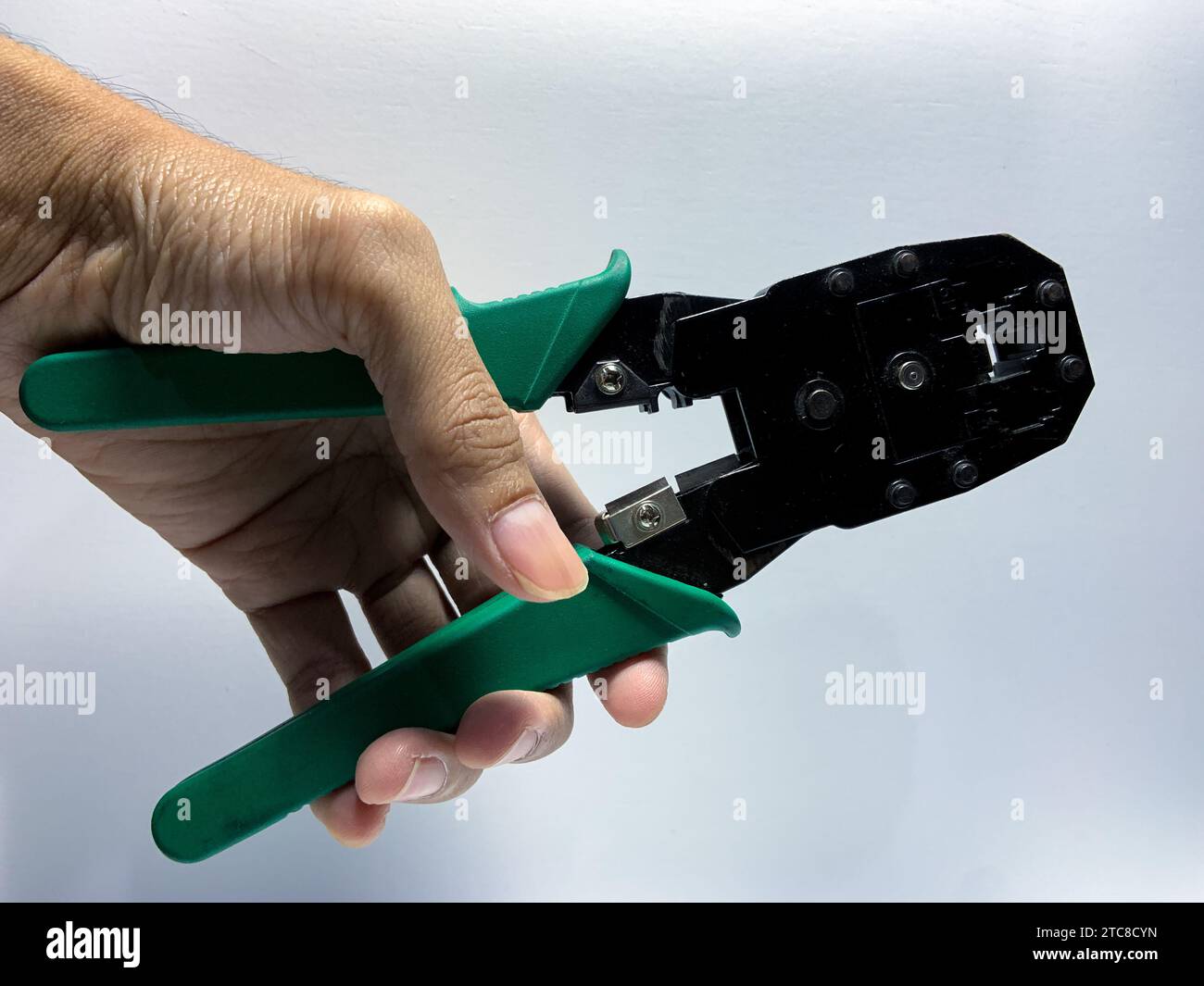 Hand holding Lan RJ45 3in1 Crimping Tool Pliers on white background ...