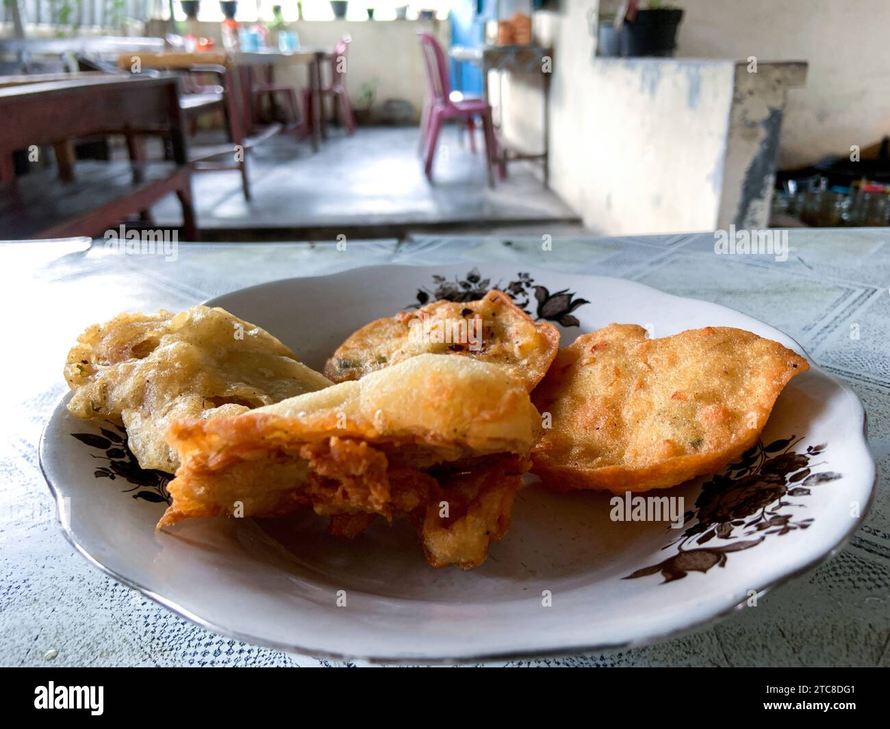 Mendoan and bakwan goreng dishes are served in traditional Indonesian ...