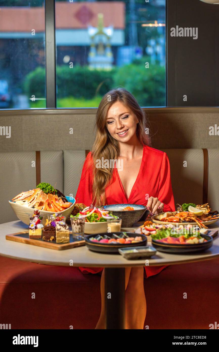 Elegant woman enjoys gourmet meal at restaurant. Dining and cuisine ...