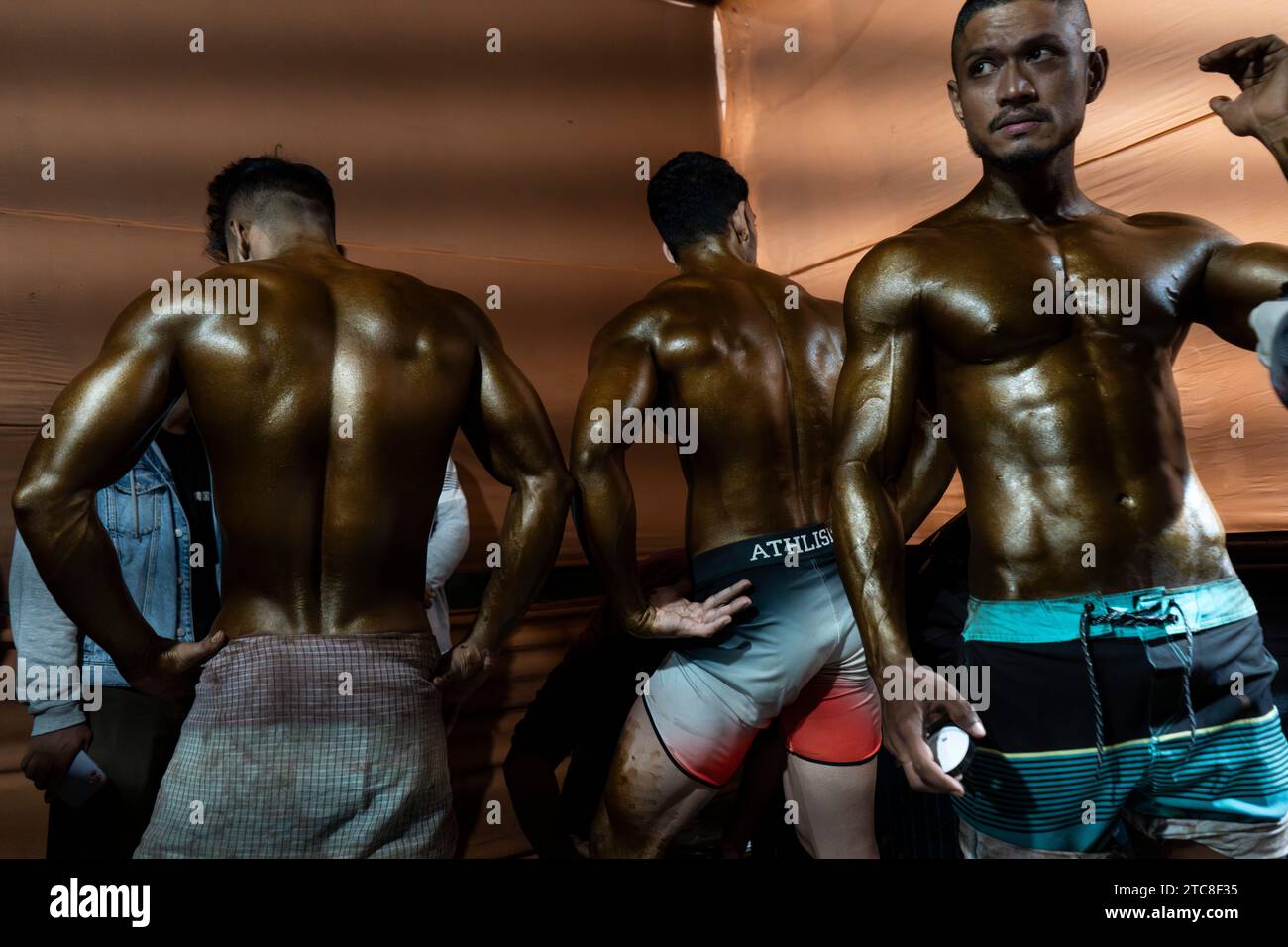 December 10, 2023: Participants gets their body painted with tanning ...