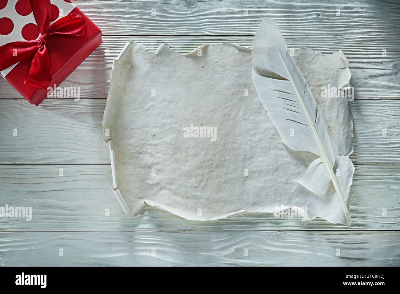 Plume vintage paper sheet packed gift box on wood board Stock Photo - Alamy
