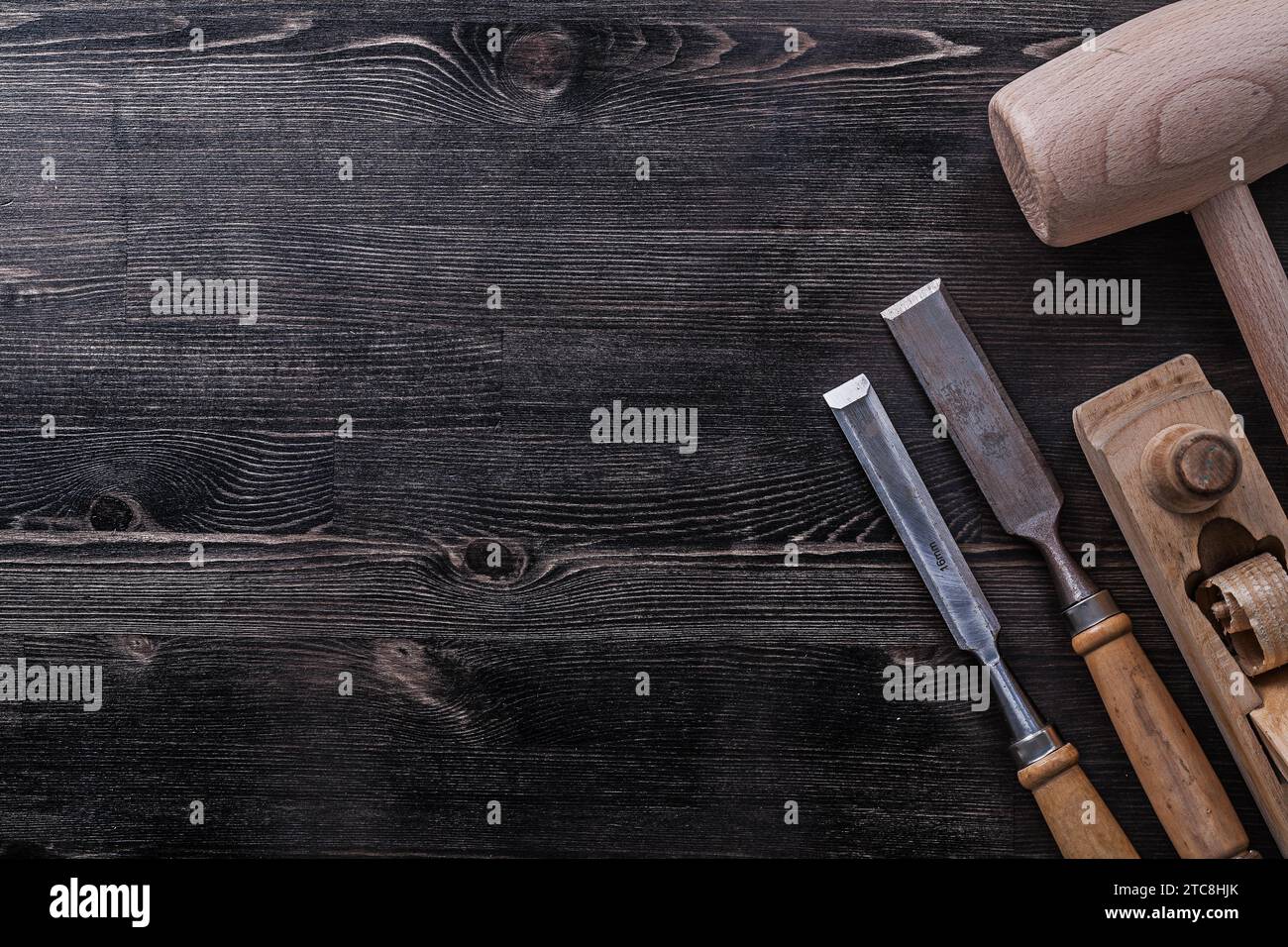 Flat chisels wooden mallet planer on wood board construction concept ...