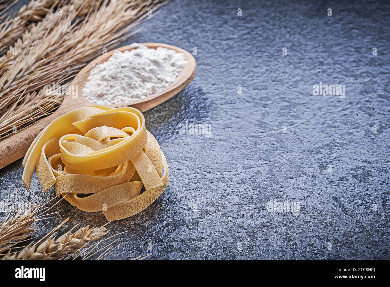 Golden wheat rye ears wooden spoon flour long-cut twisted macaroni on ...