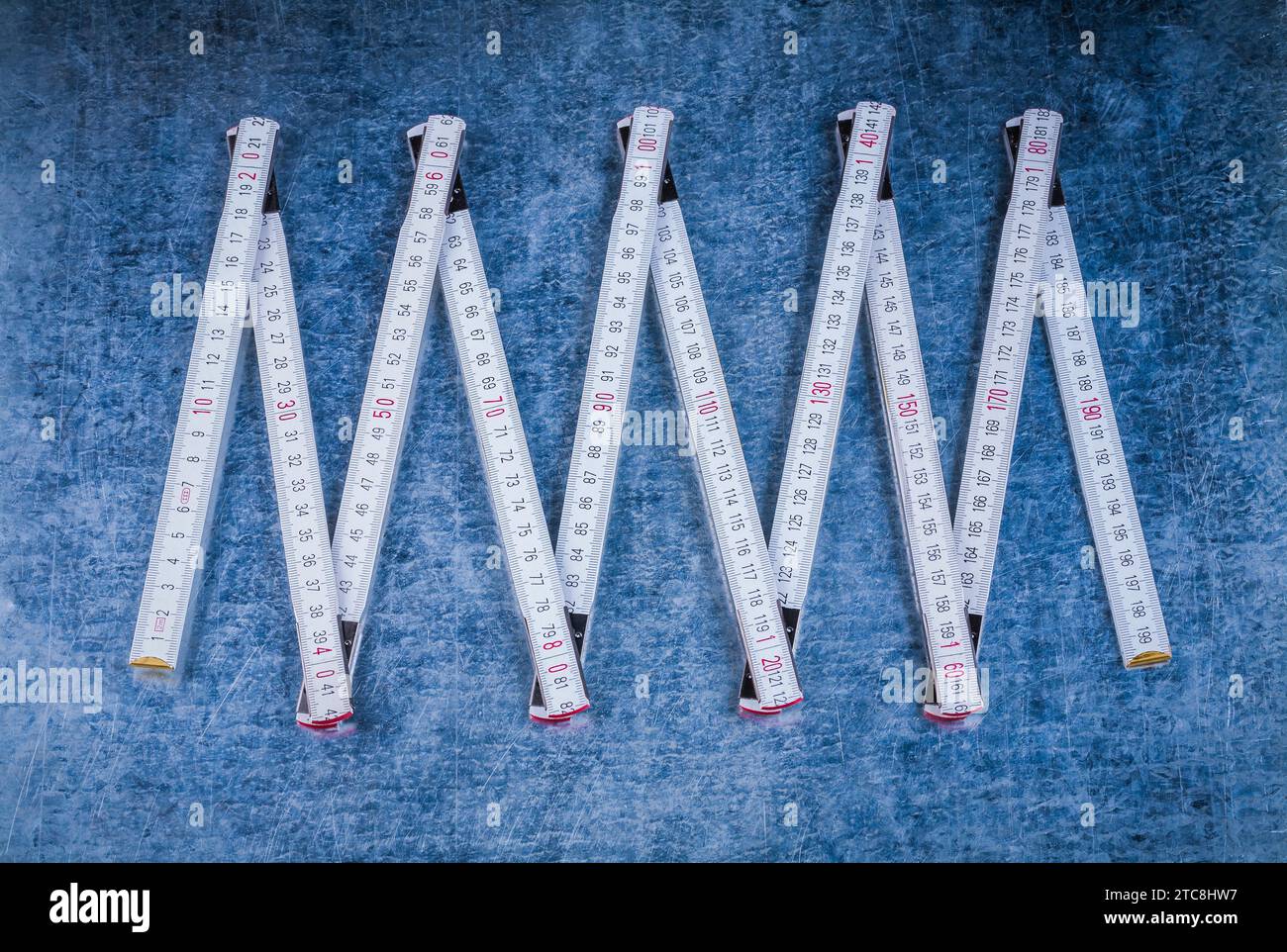 Measuring wooden meter on scratched metallic background construction ...