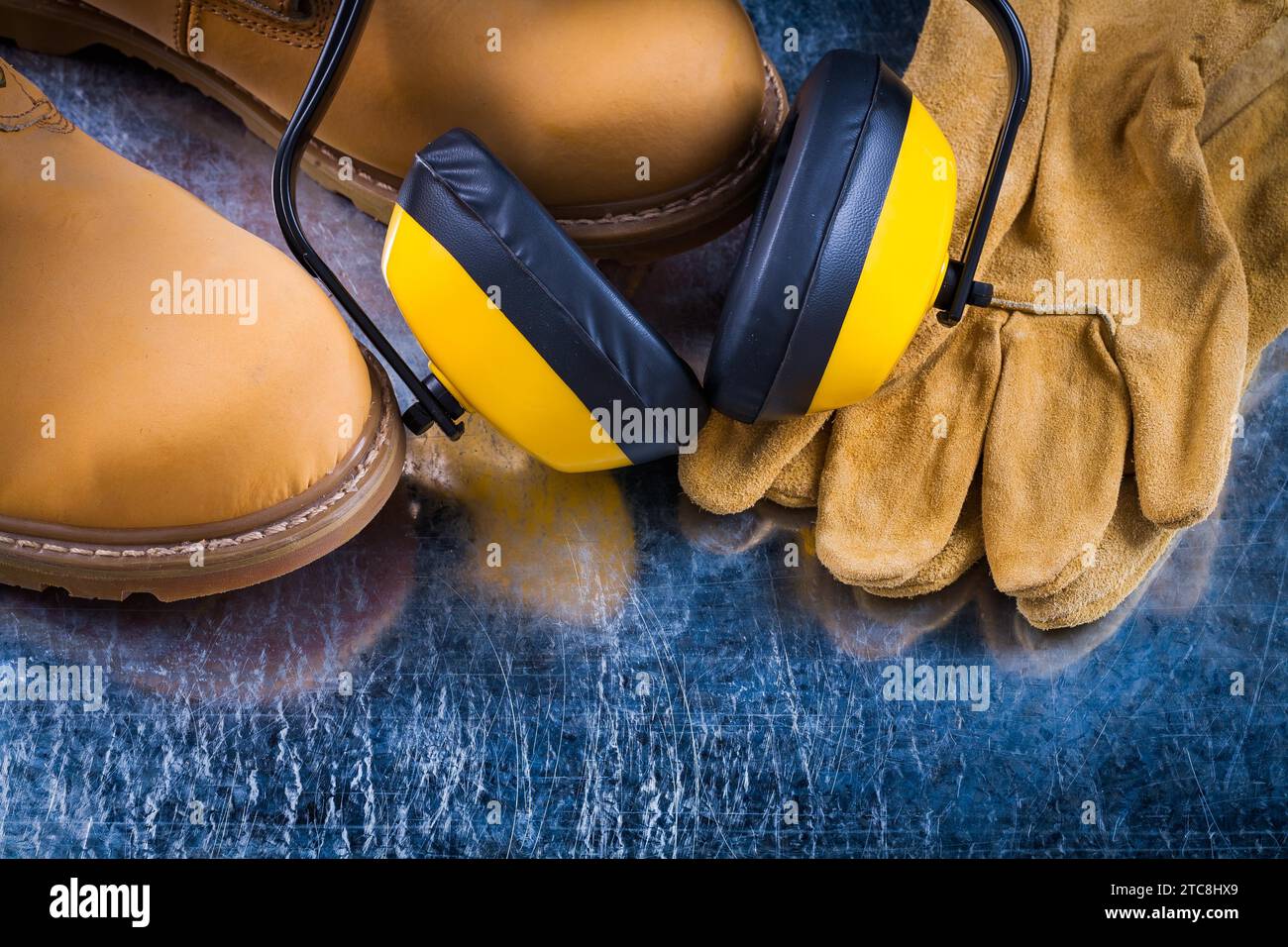 Leather boots protective gloves and noise reduction ear muffs on ...