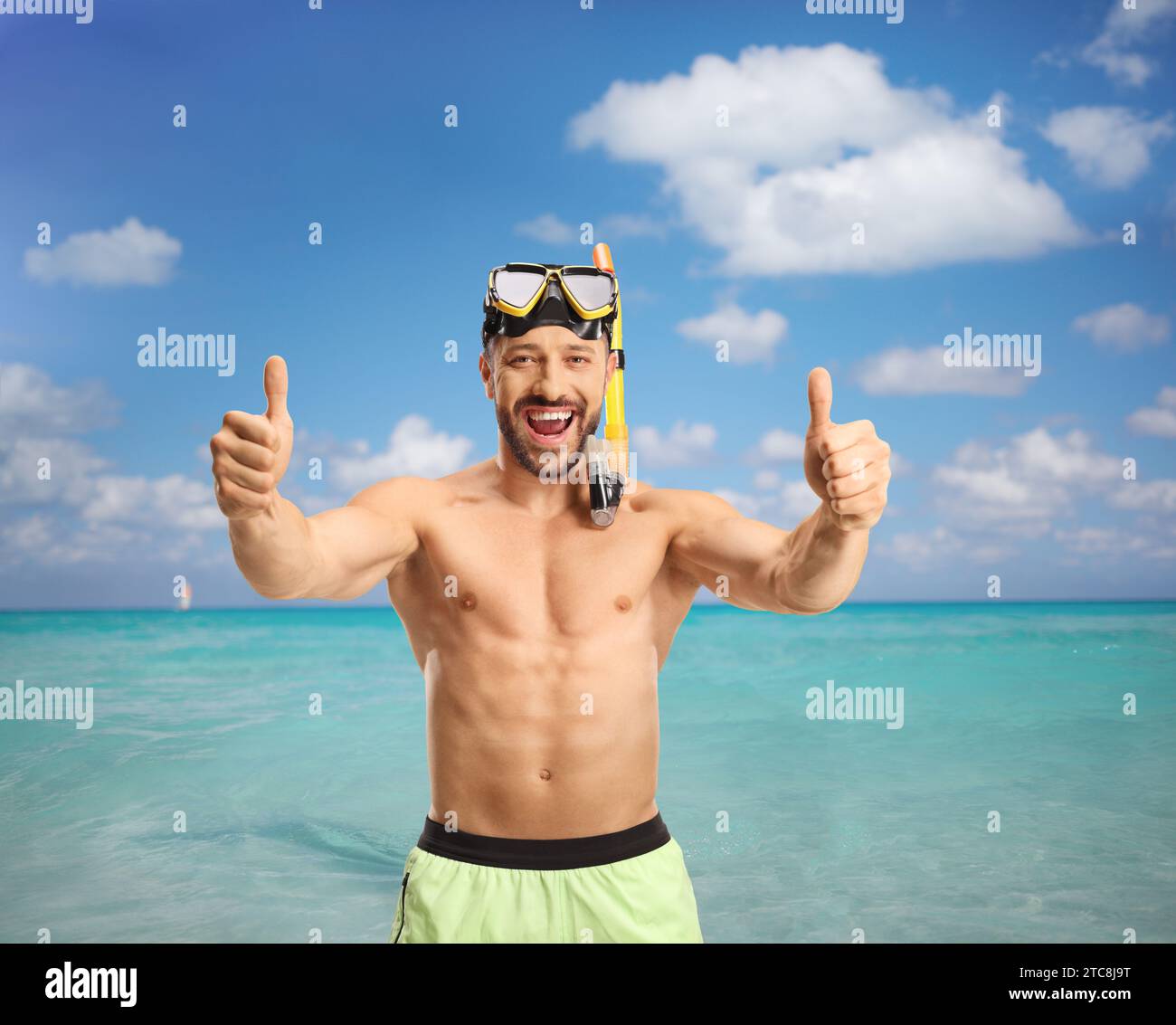 Cheerful man into the sea with a diving mask showing thumbs up Stock ...