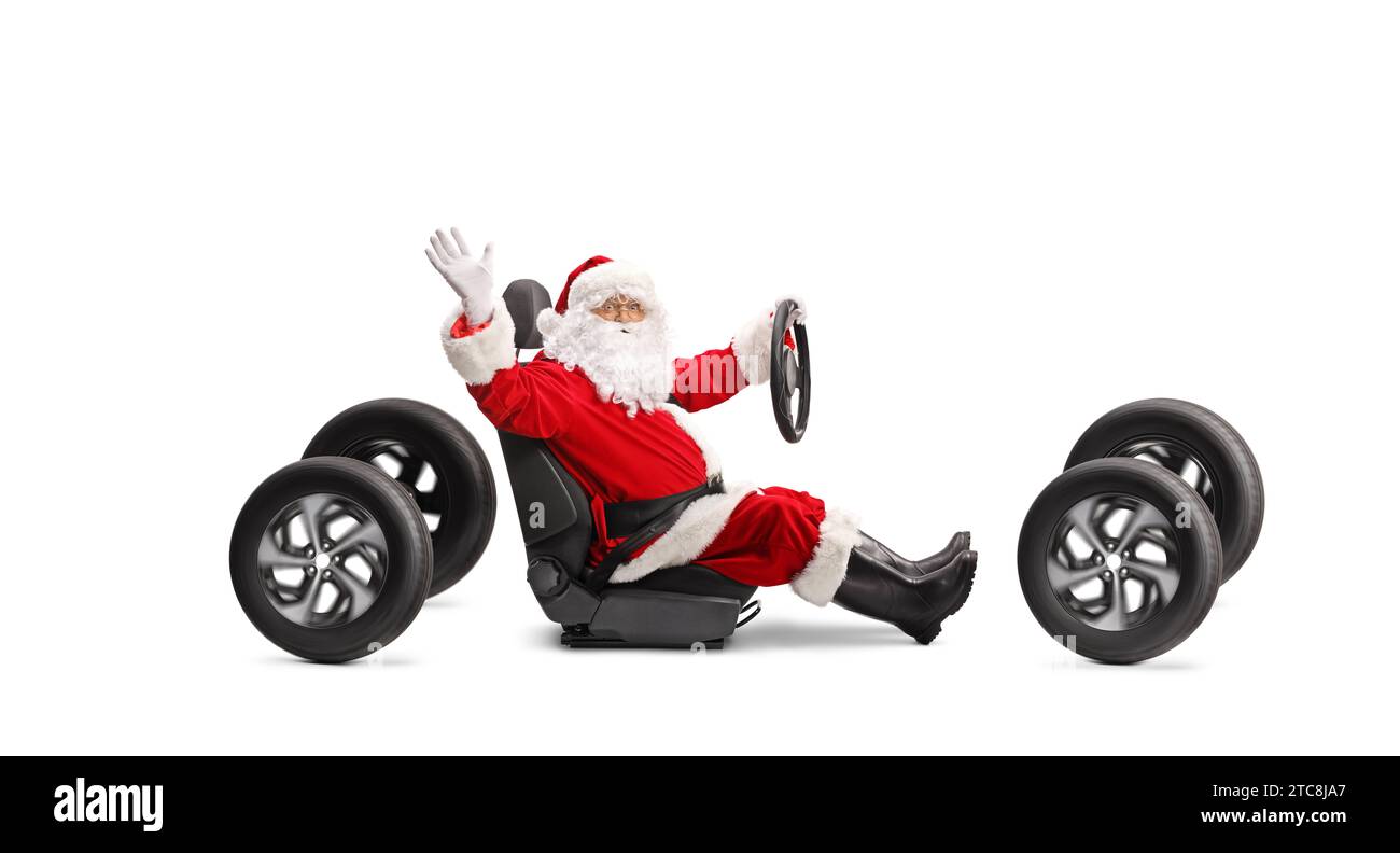 Santa Claus in a car seat holding a steering wheel and waving isolated ...