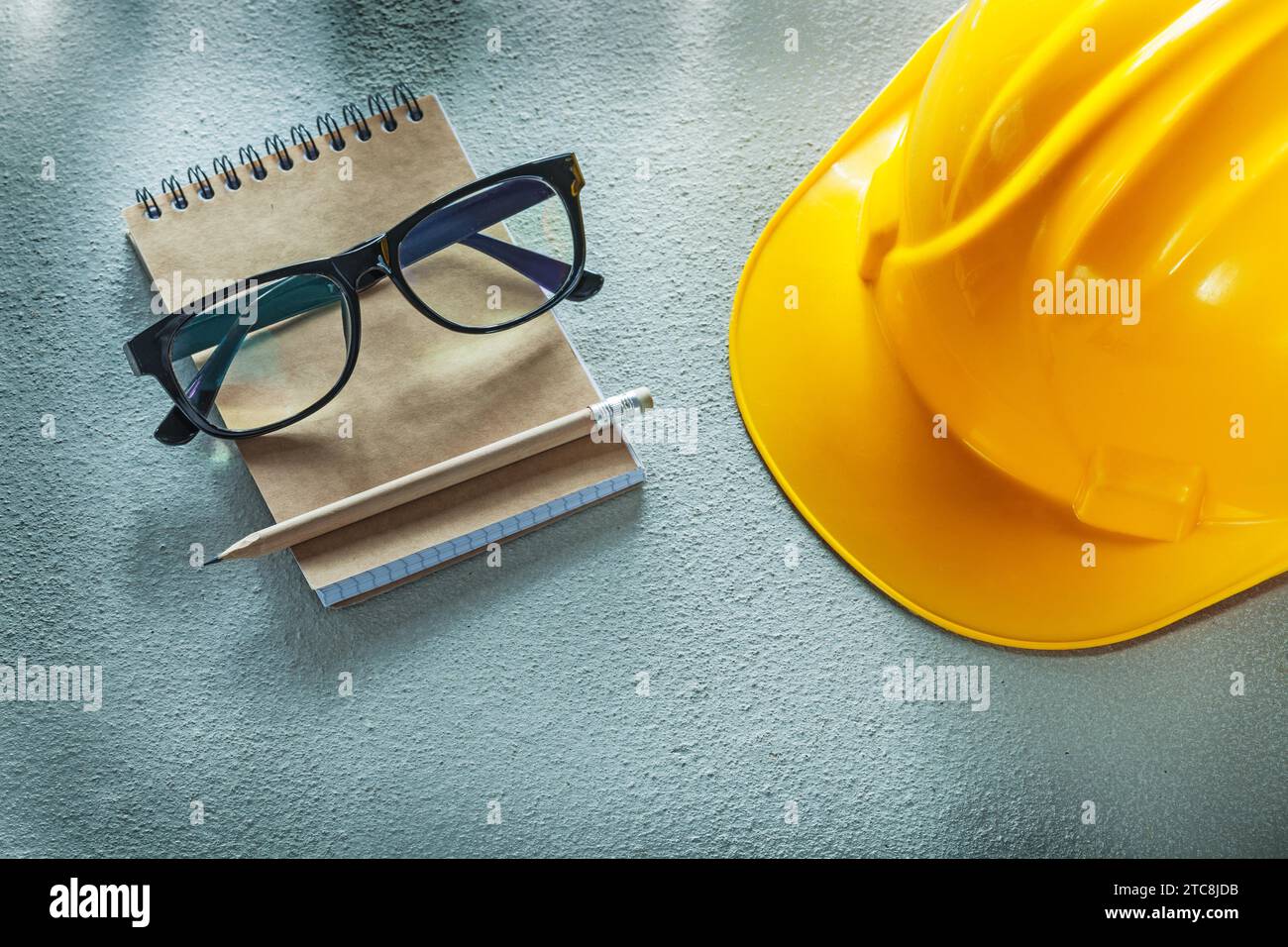 Safety cap glasses notebook pencil on concrete background Stock Photo ...