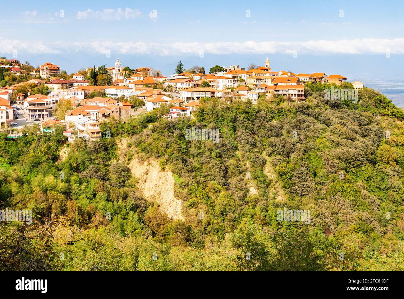 travel to Georgia - view of Signagi town illuminated by sun on mountain ...