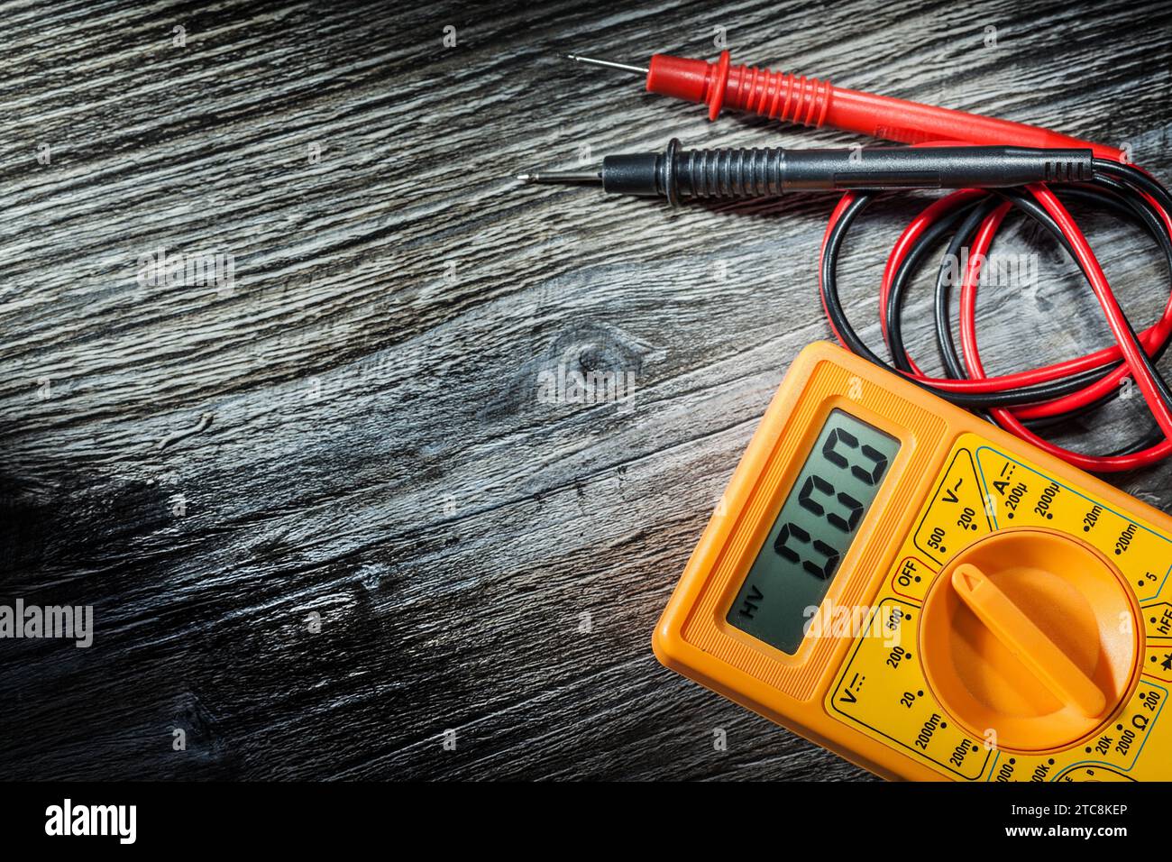 Electric multitester on wooden board Stock Photo - Alamy