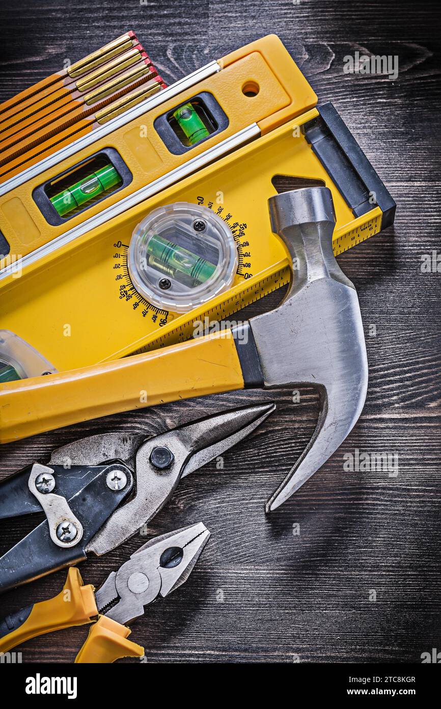 Construction level wooden meter pliers wire cutter hammer vertical view ...