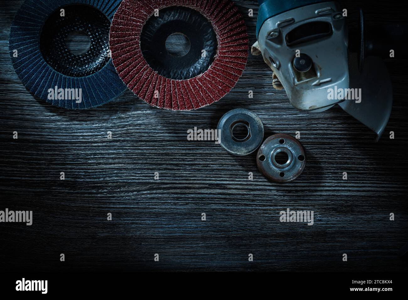 Hand angle grinder rotary grinding discs on vintage wooden board Stock ...