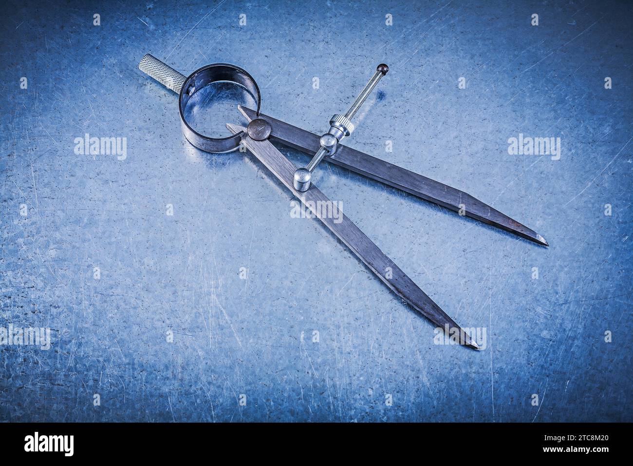 Metal construction pair of compasses on metallic background Stock Photo ...