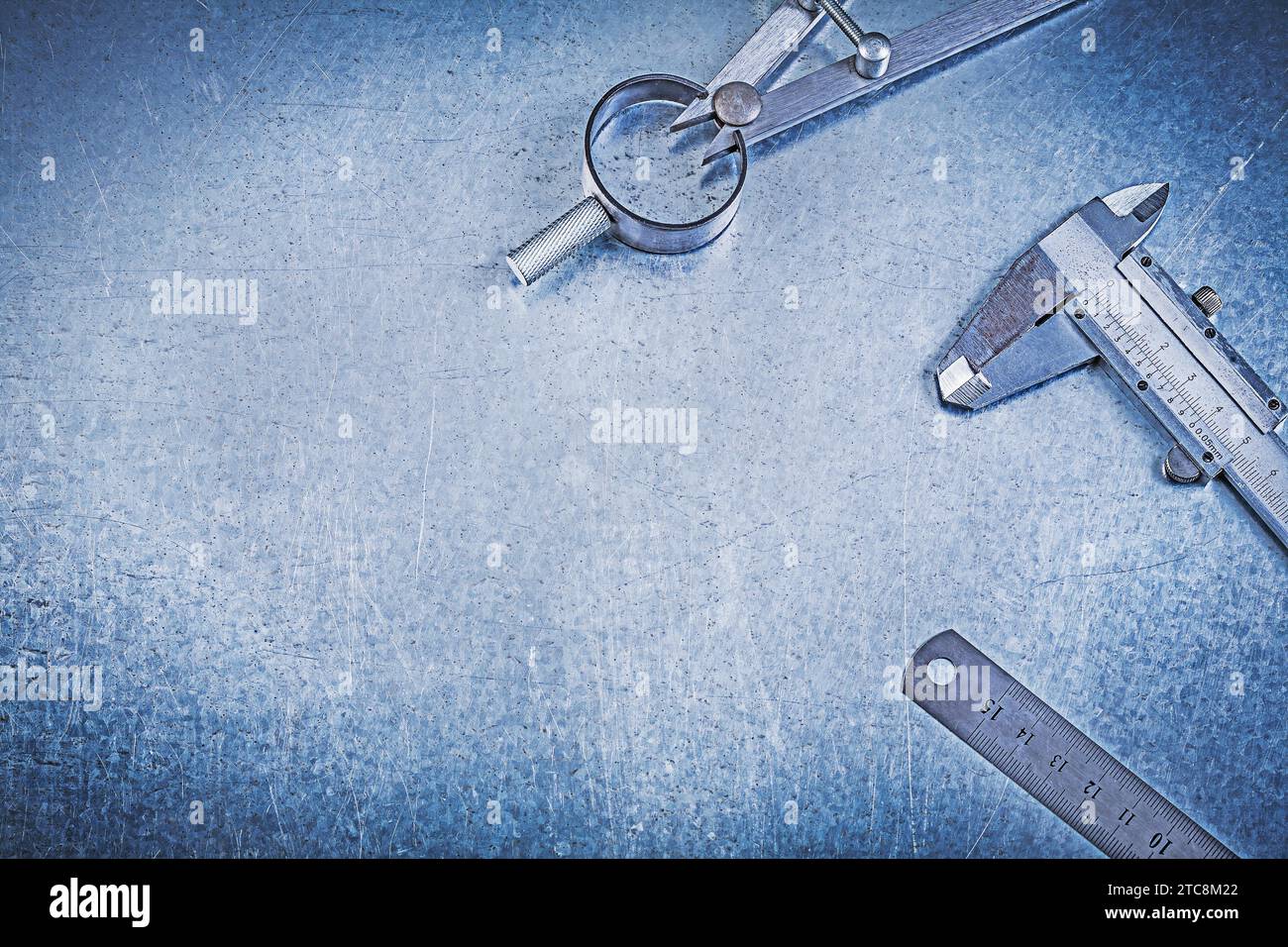 Metal construction divider ruler vernier caliper on metallic background ...