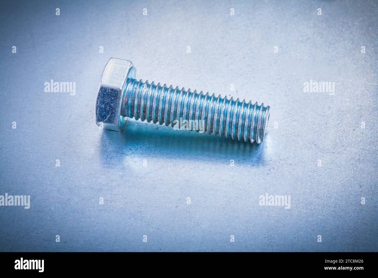 Metal construction screw bolt on metallic background repairing concept ...