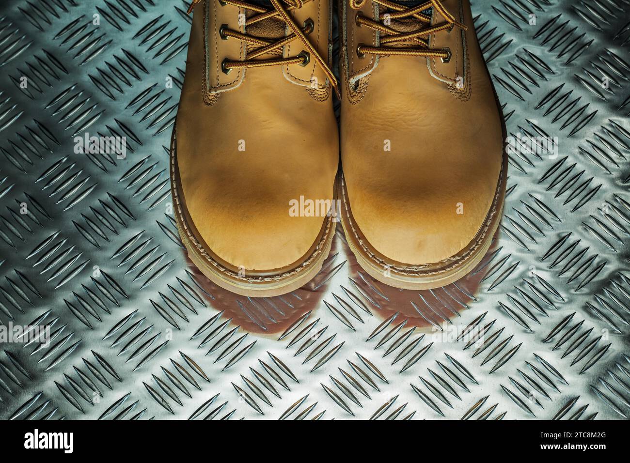 Pair of safety boots on corrugated metal plate Stock Photo - Alamy