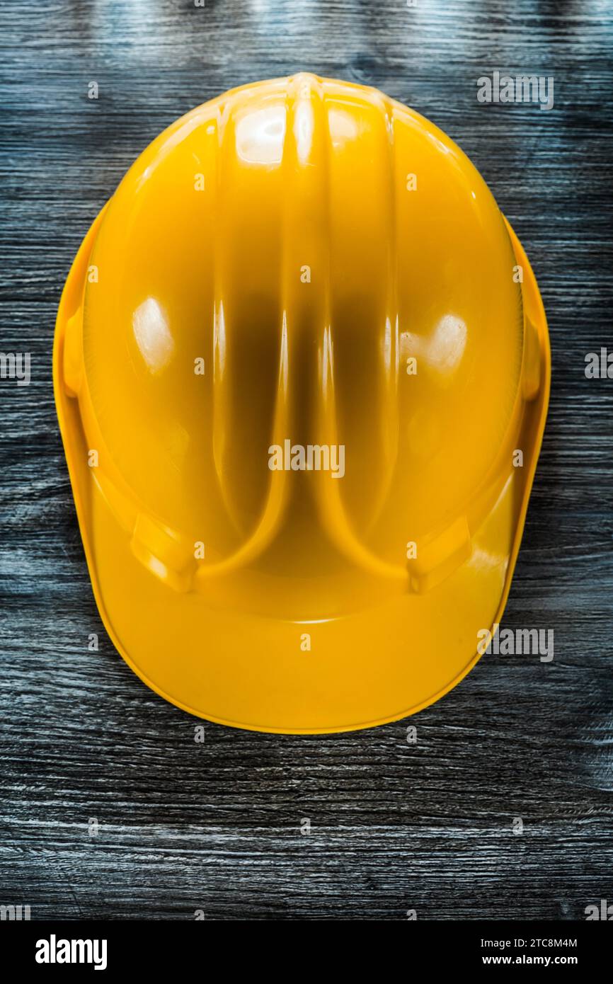 Protective building helmet on wooden board Stock Photo - Alamy
