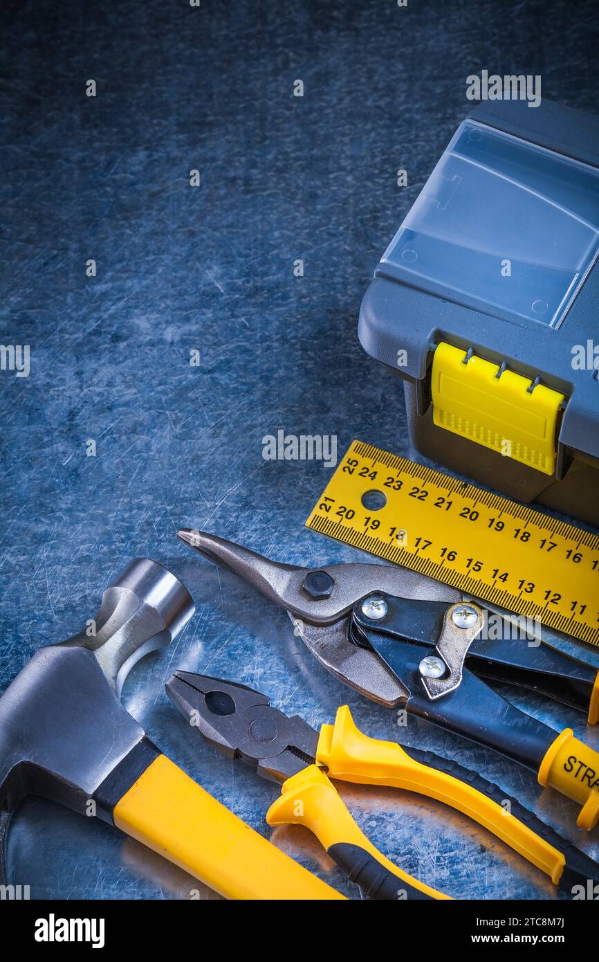 Scratched vintage metallic background with toolbox claw hammer ruler ...