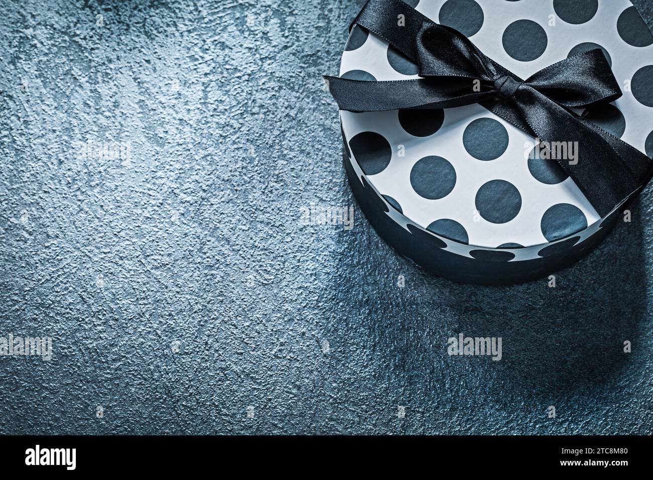 Round present box on black background holidays concept Stock Photo - Alamy