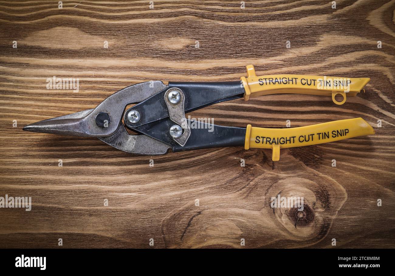 Steel cutter on vintage wooden board top view construction concept ...