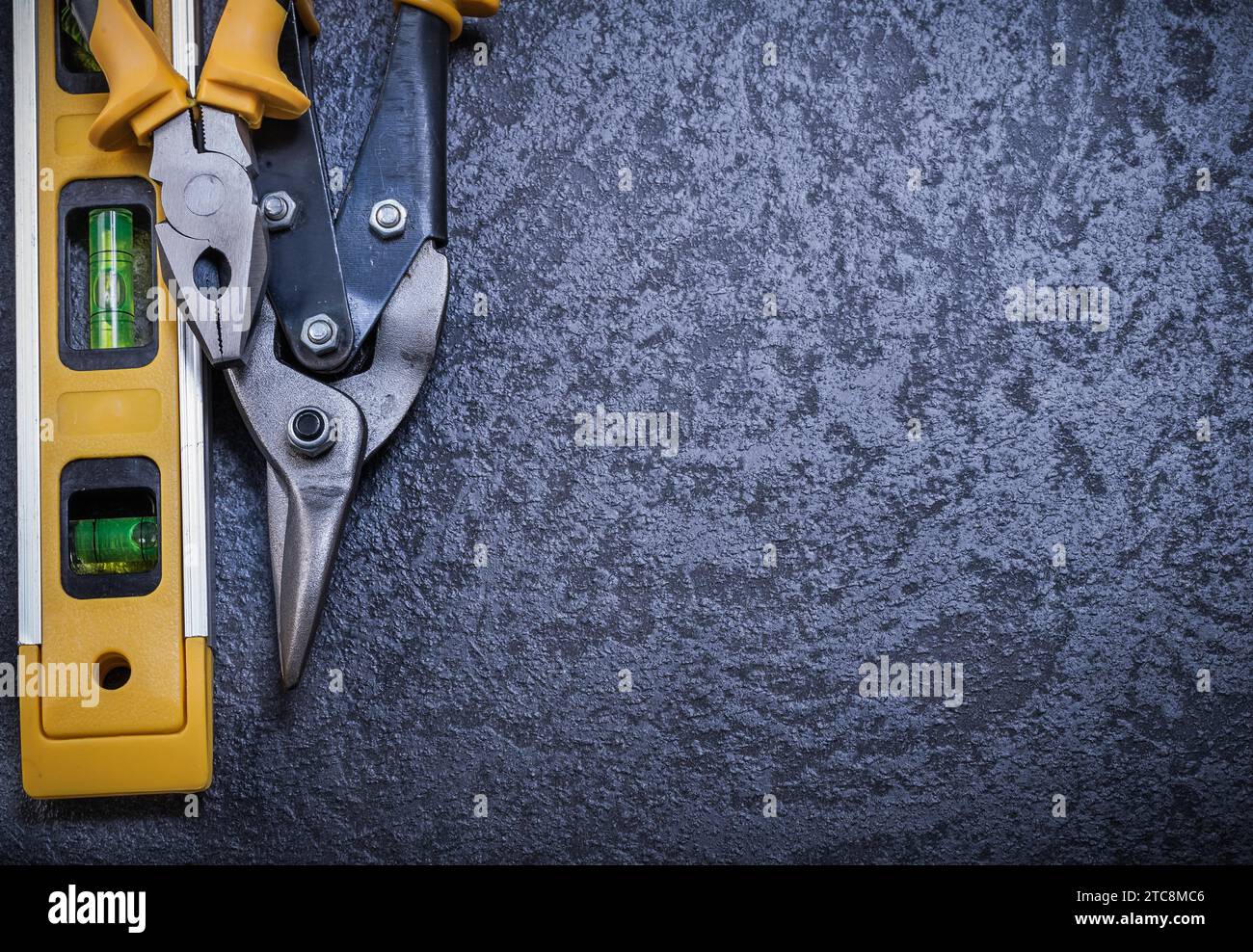 Stainless steel cutter gripping tongs construction level on black ...