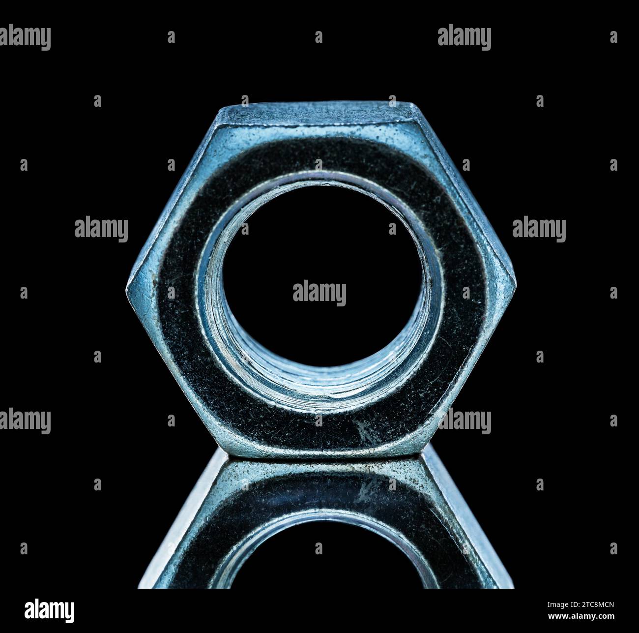 Threaded nuts on black background Stock Photo - Alamy