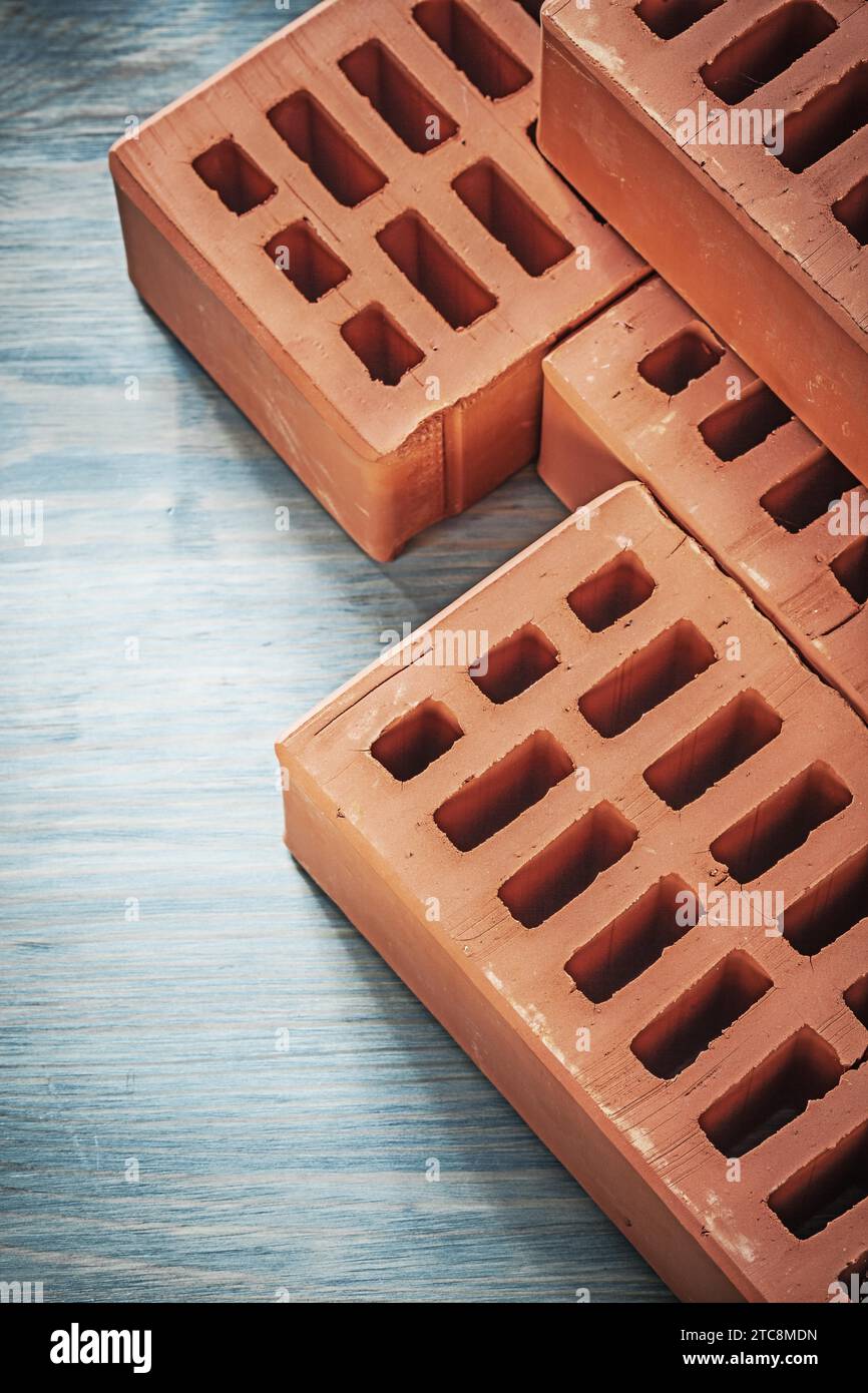Vertical image of red bricks on wooden board construction concept Stock ...