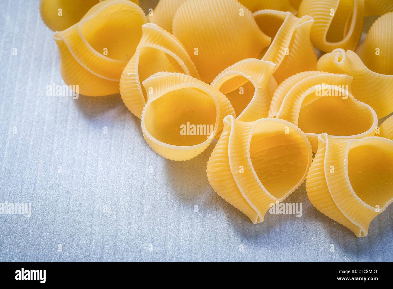 Uncooked pasta shells on blue background food and drink concept Stock ...