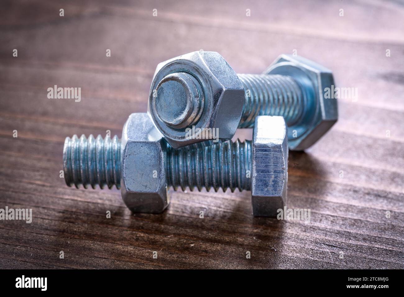 Vintage wooden board with pair of metal threaded bolts and nuts ...