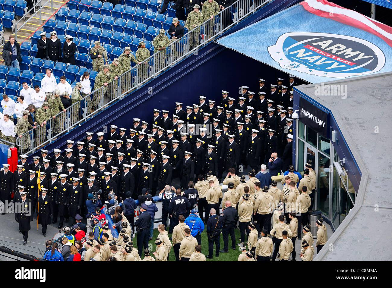 A formation of Navy Midshipmen march into the stadium before an NCAA ...