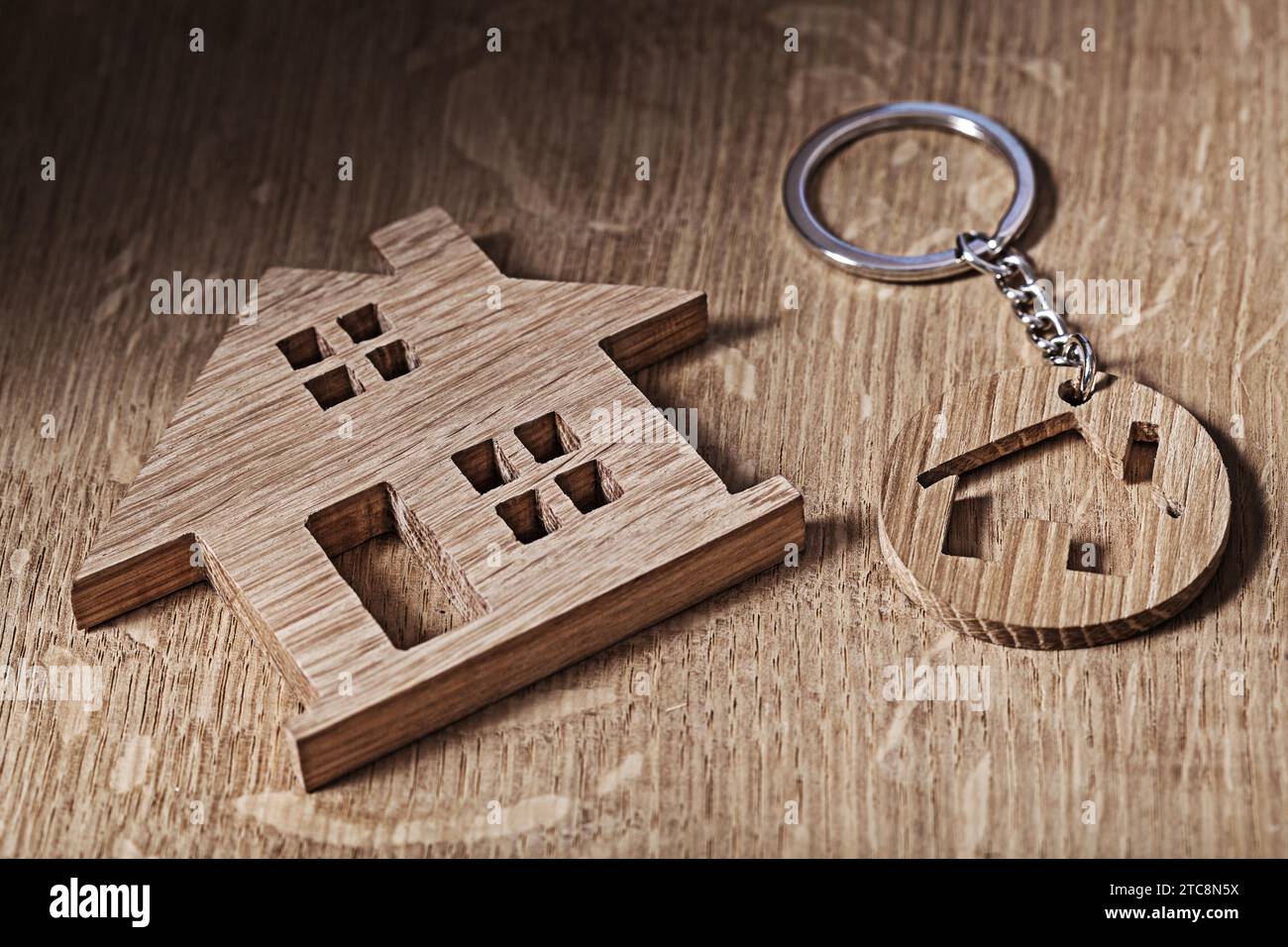 Trinket house symbols on wood backround Stock Photo - Alamy