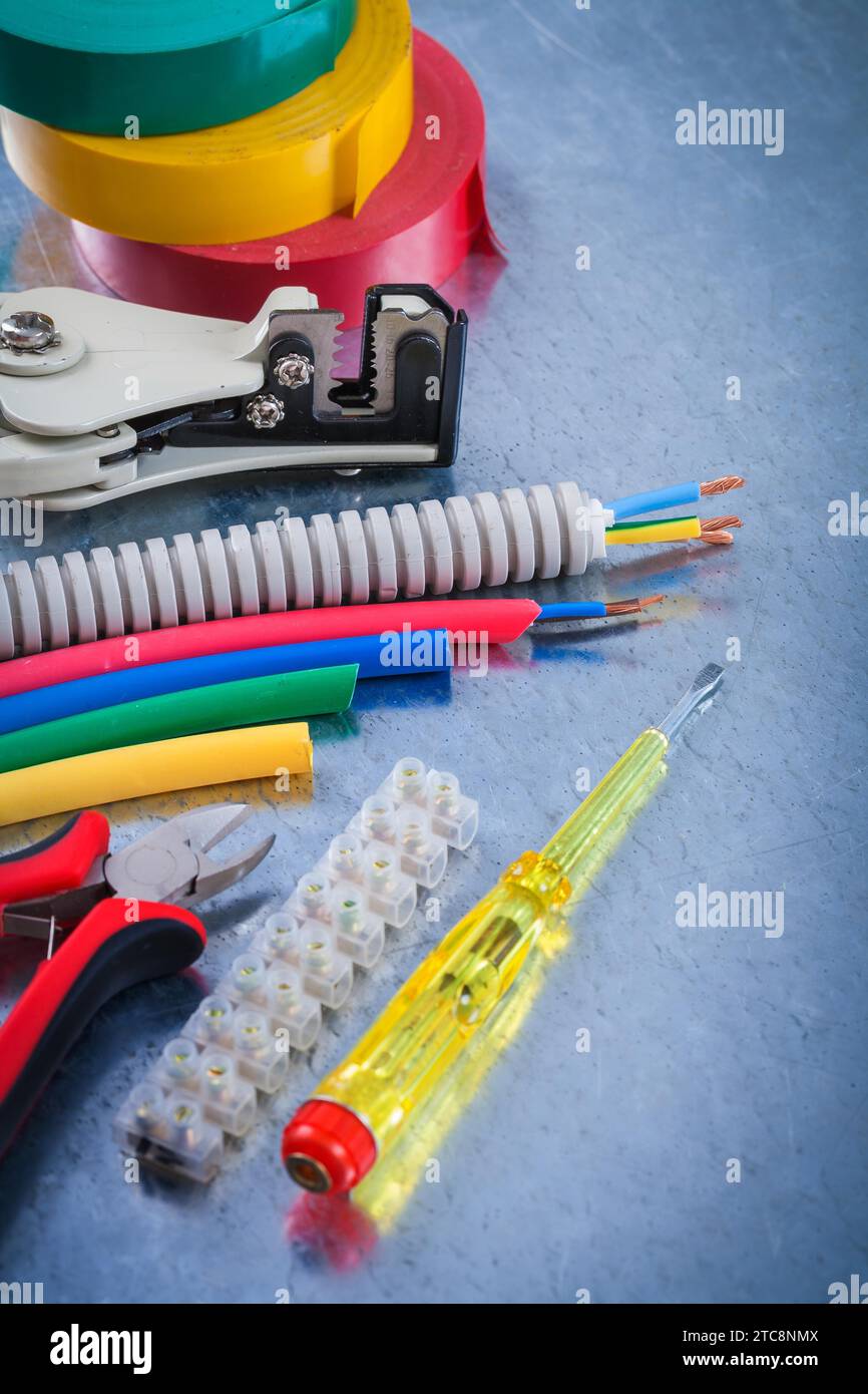 Collection of electrical tools on scratched metallic background ...