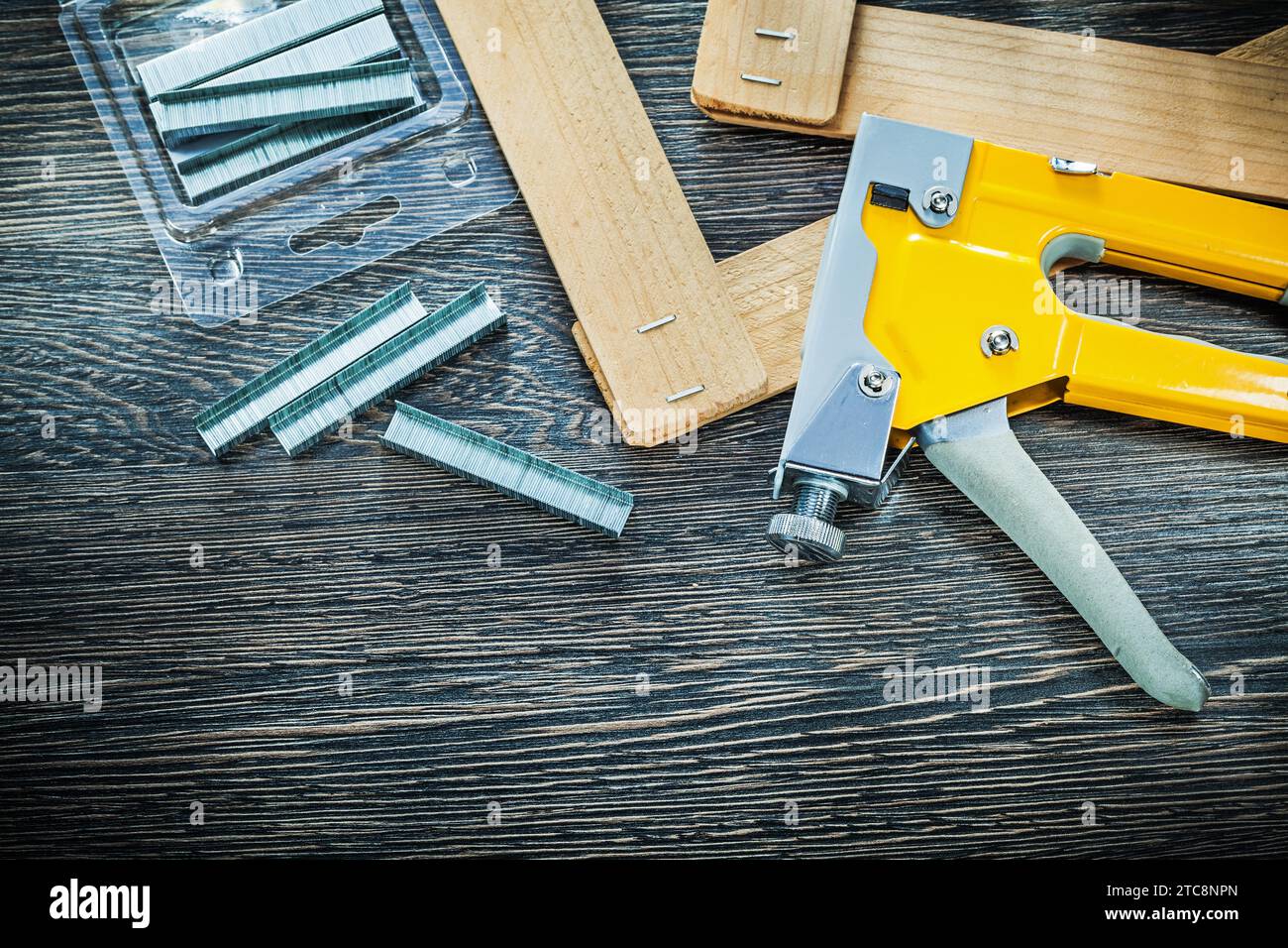 Construction stapler staples wooden planks top view Stock Photo - Alamy