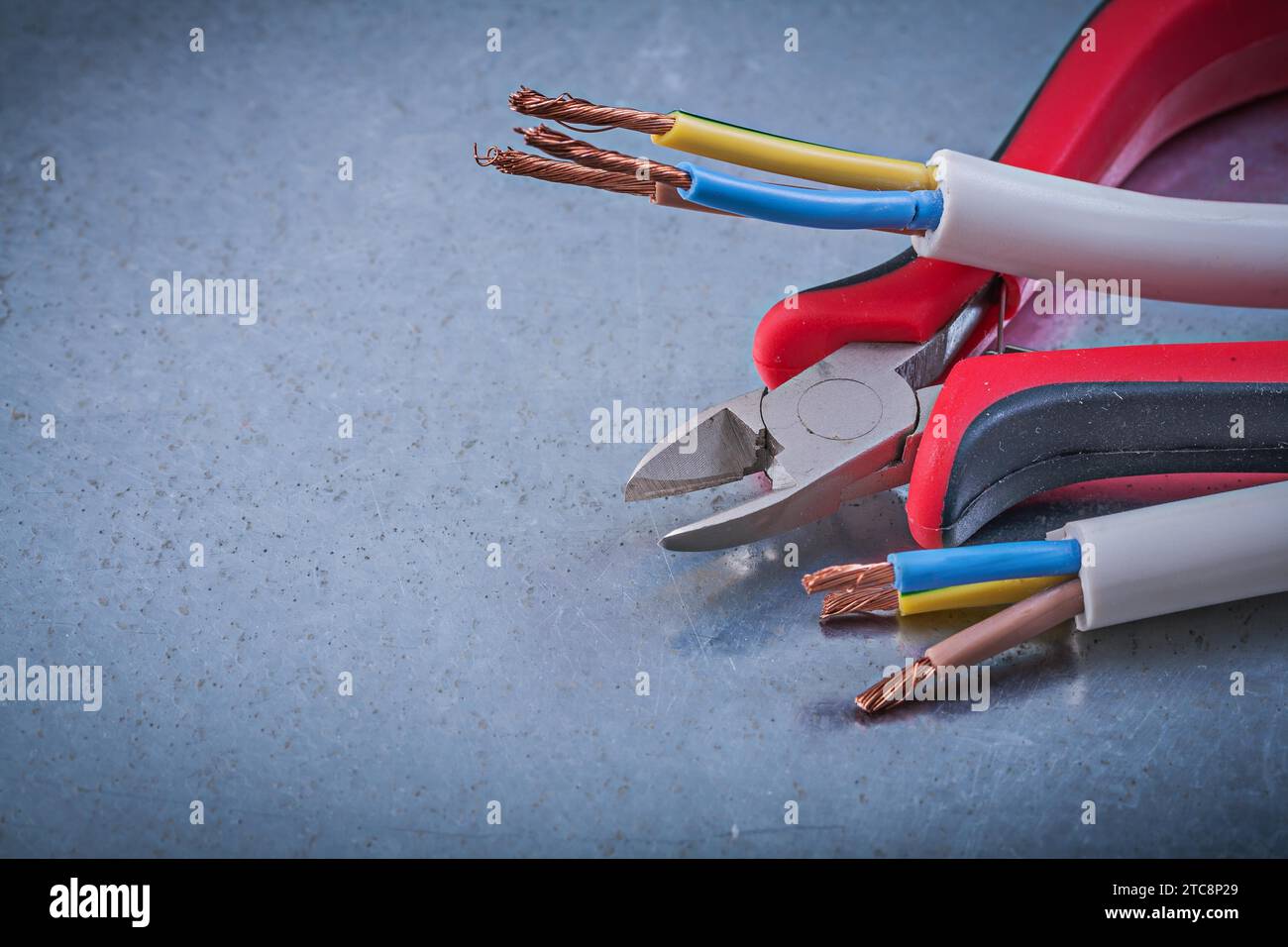 Electrical cables wires nippers on scratched metallic background ...