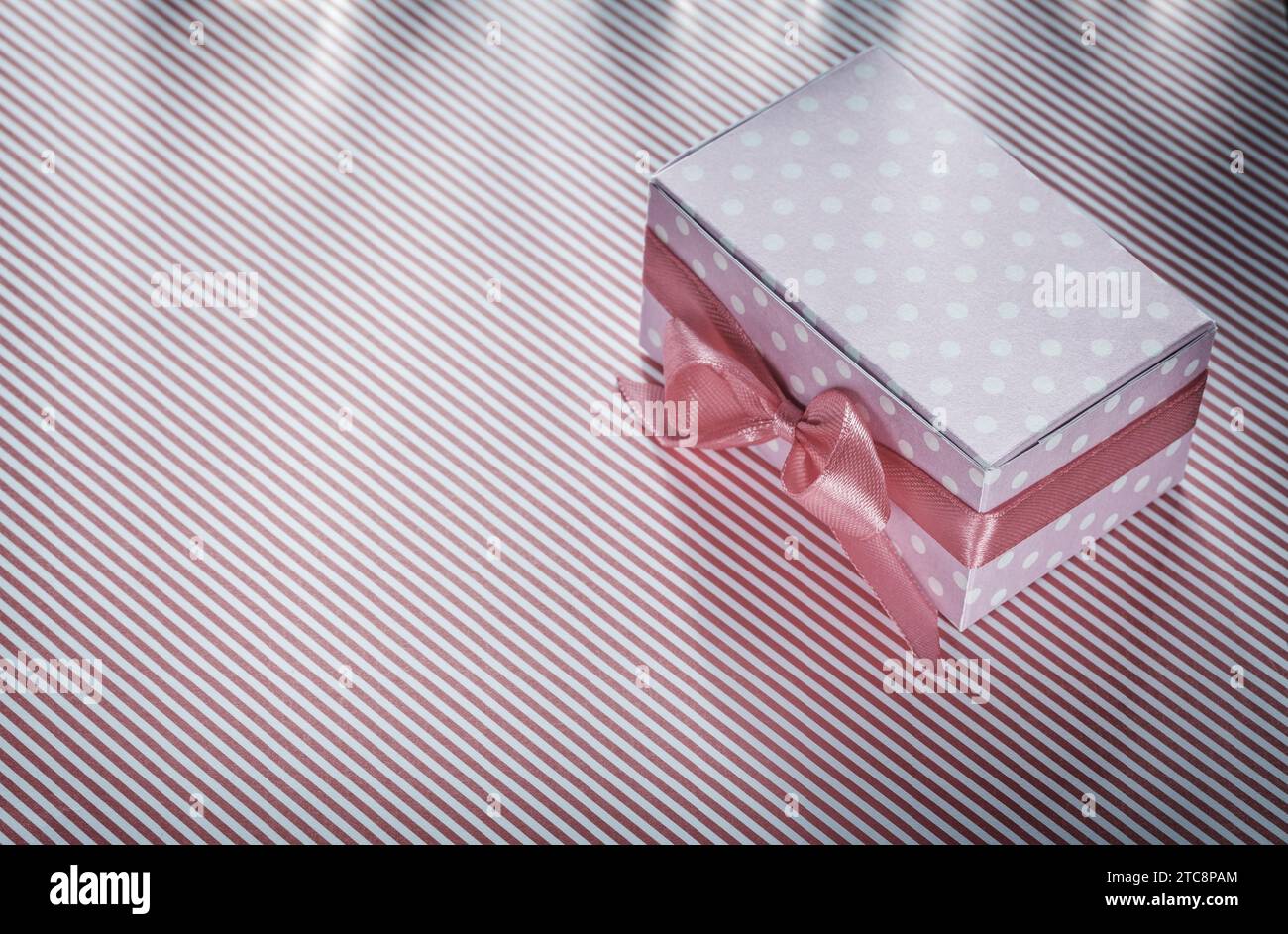Gift box on red striped tablecloth celebrations concept Stock Photo - Alamy